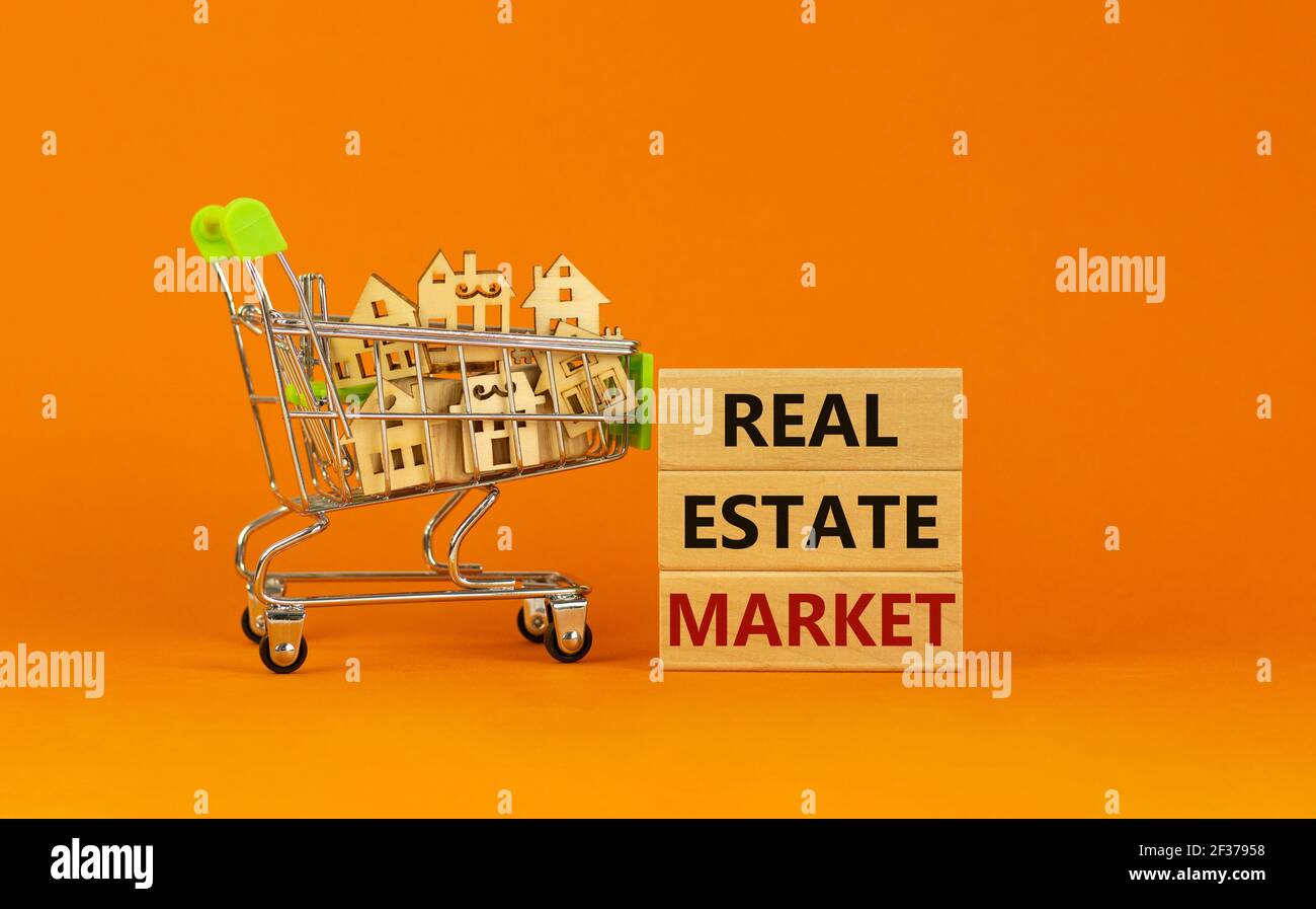 Real estate market symbol. Wooden blocks, words 'Real estate market' on ...