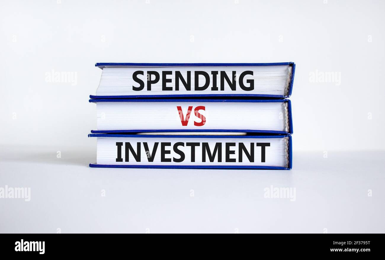 Spending vs investment strategy symbol. Books with words 'Spending vs ...