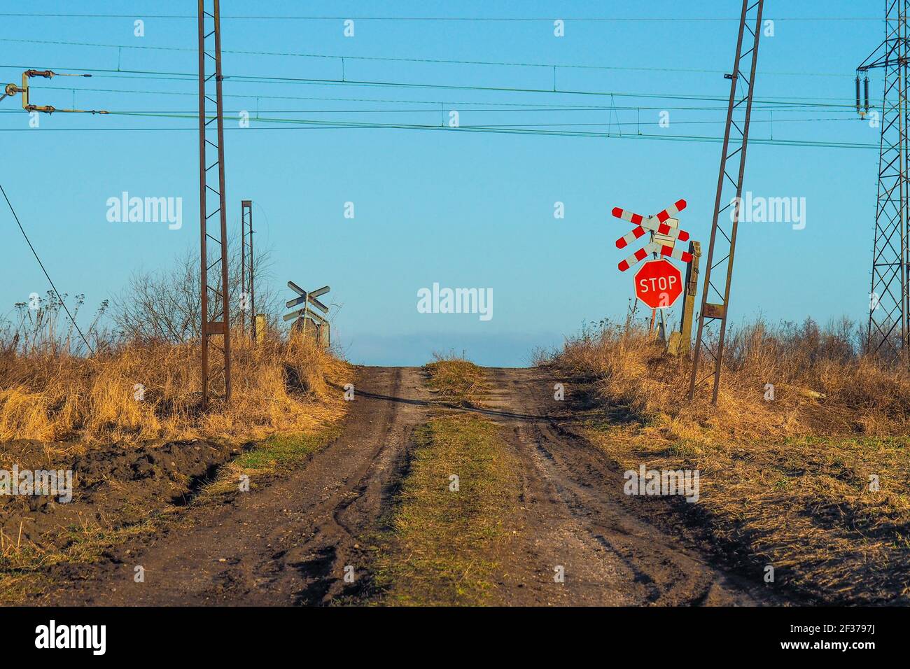 a muddy dirt road that ends with a STOP sign Stock Photo - Alamy