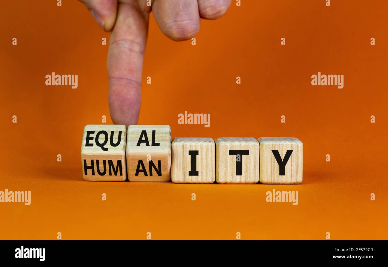 Equality and humanity symbol. Businessman turns wooden cubes and ...