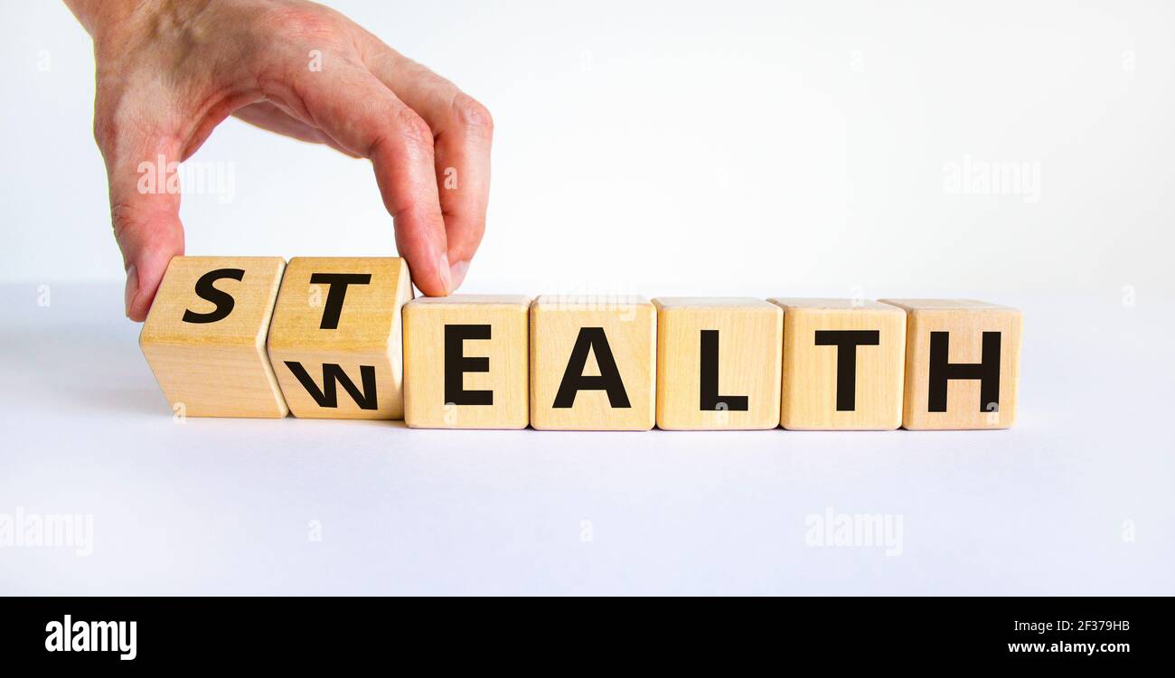 Stealth wealth symbol. Businessman turns wooden cubes and changes the ...