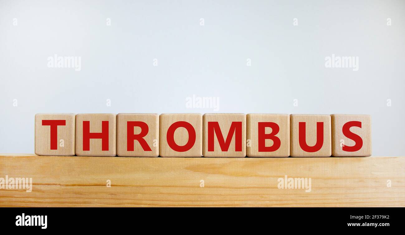 Medical and and thrombus symbol. Wooden cubes with the word 'thrombus ...