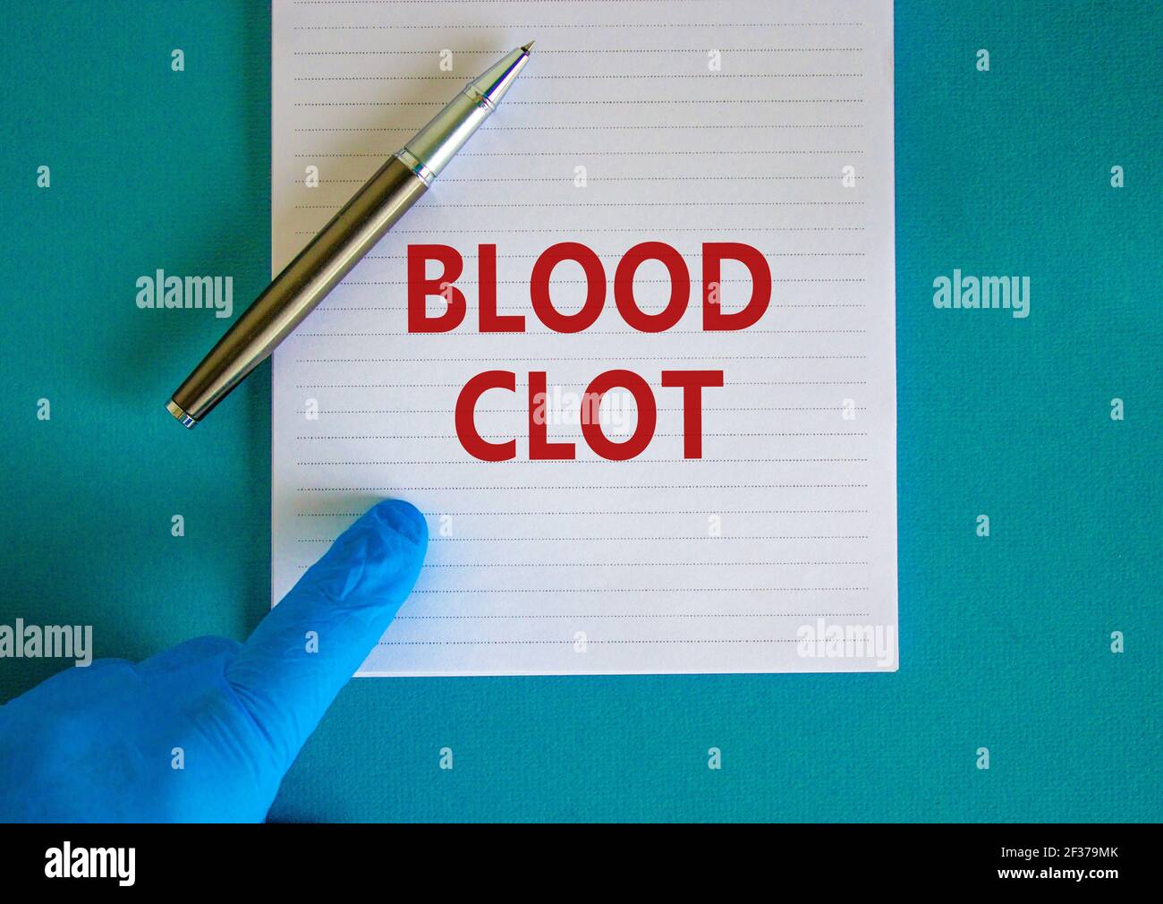 Medical and blood clot symbol. Doctor hand, metalic pen. White note ...