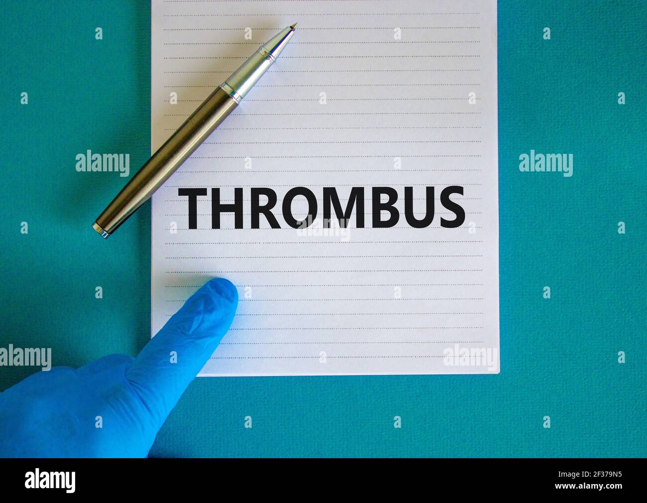 Medical and thrombus symbol. Doctor hand, metalic pen. White note with ...