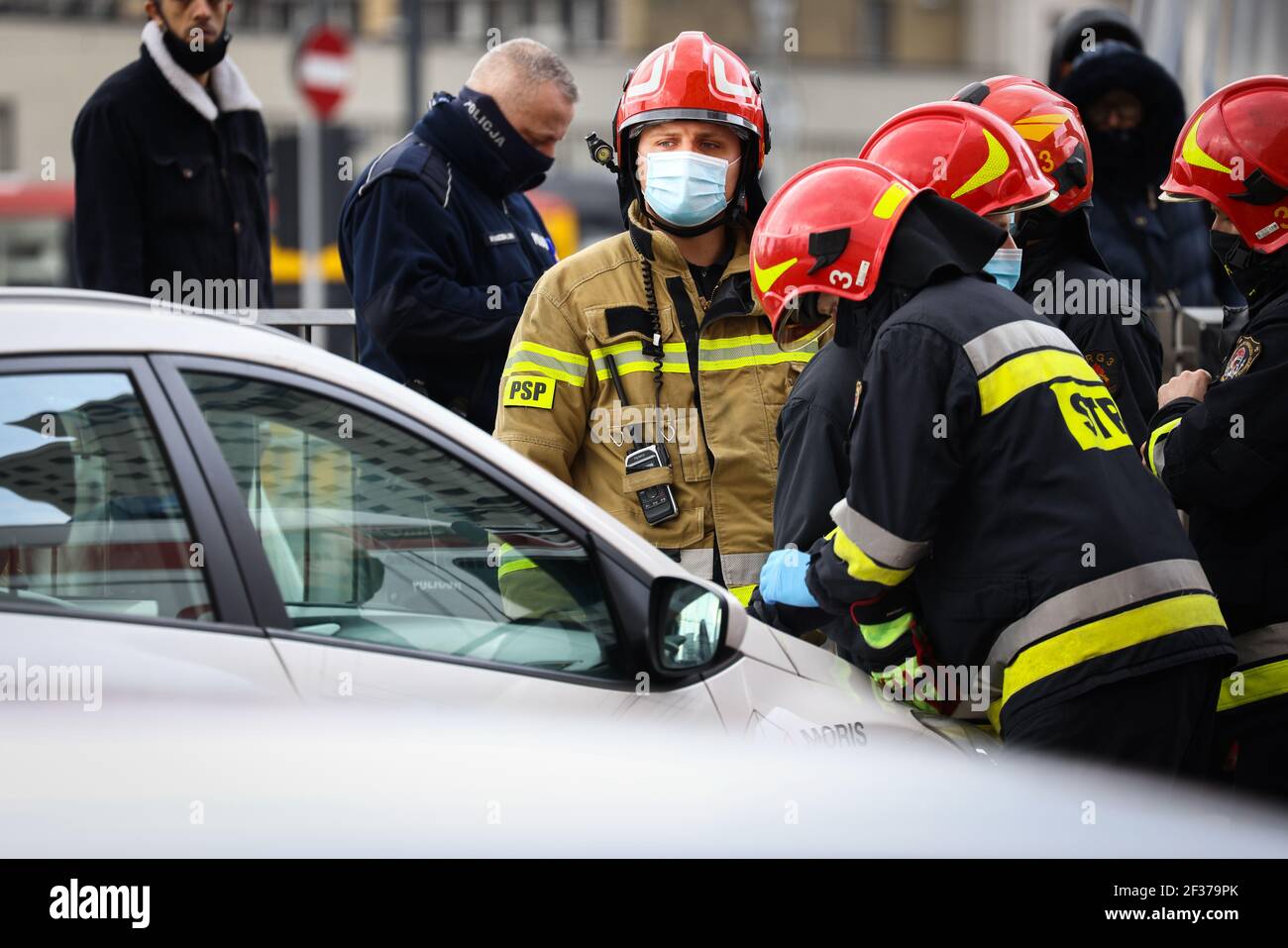 Firemen and other emergency services workers wearing face masks are ...