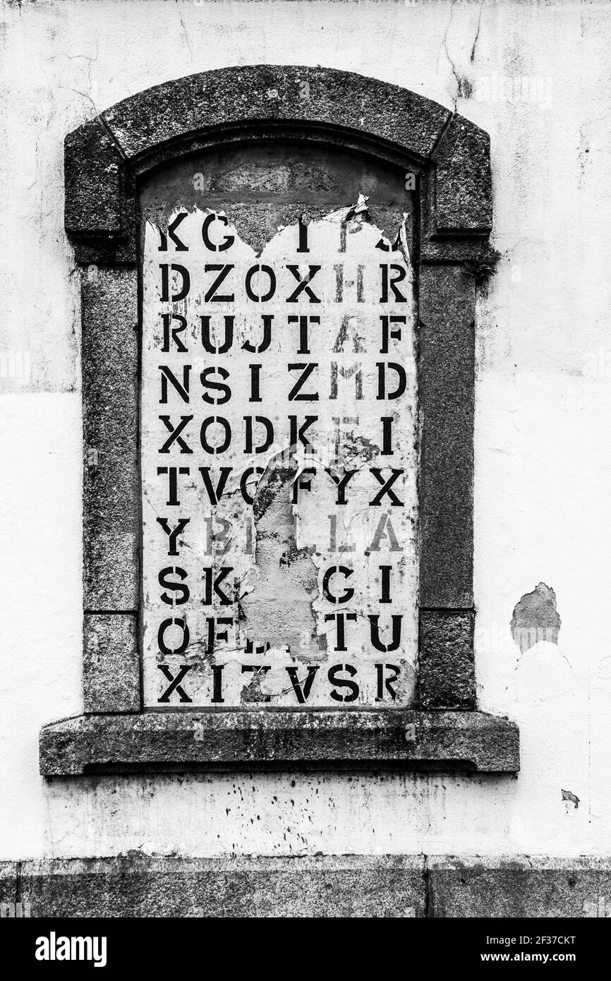 A vertical shot of a memorial with letters on the white wall background ...