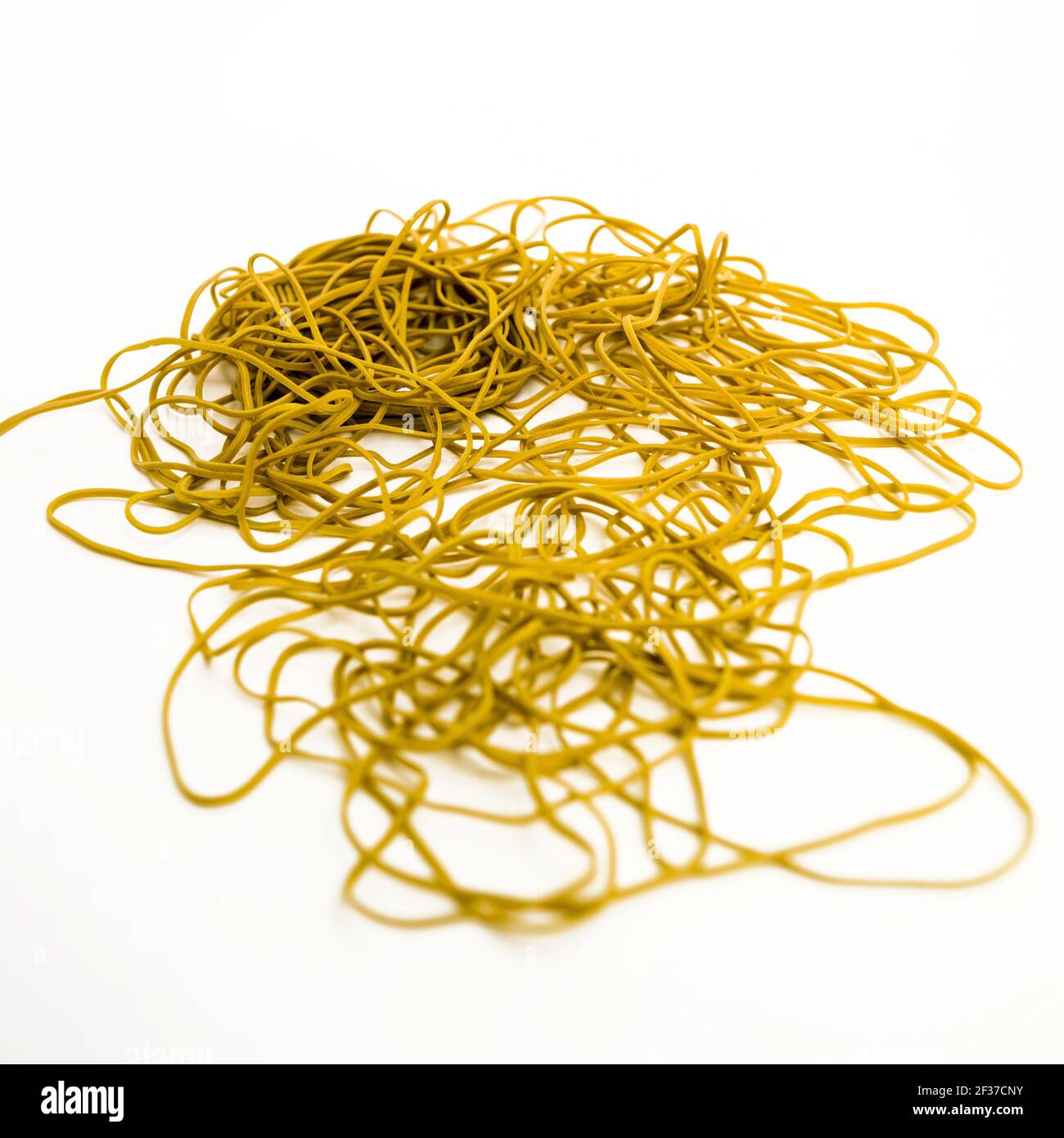 A pile of elastic bands on a white surface Stock Photo - Alamy