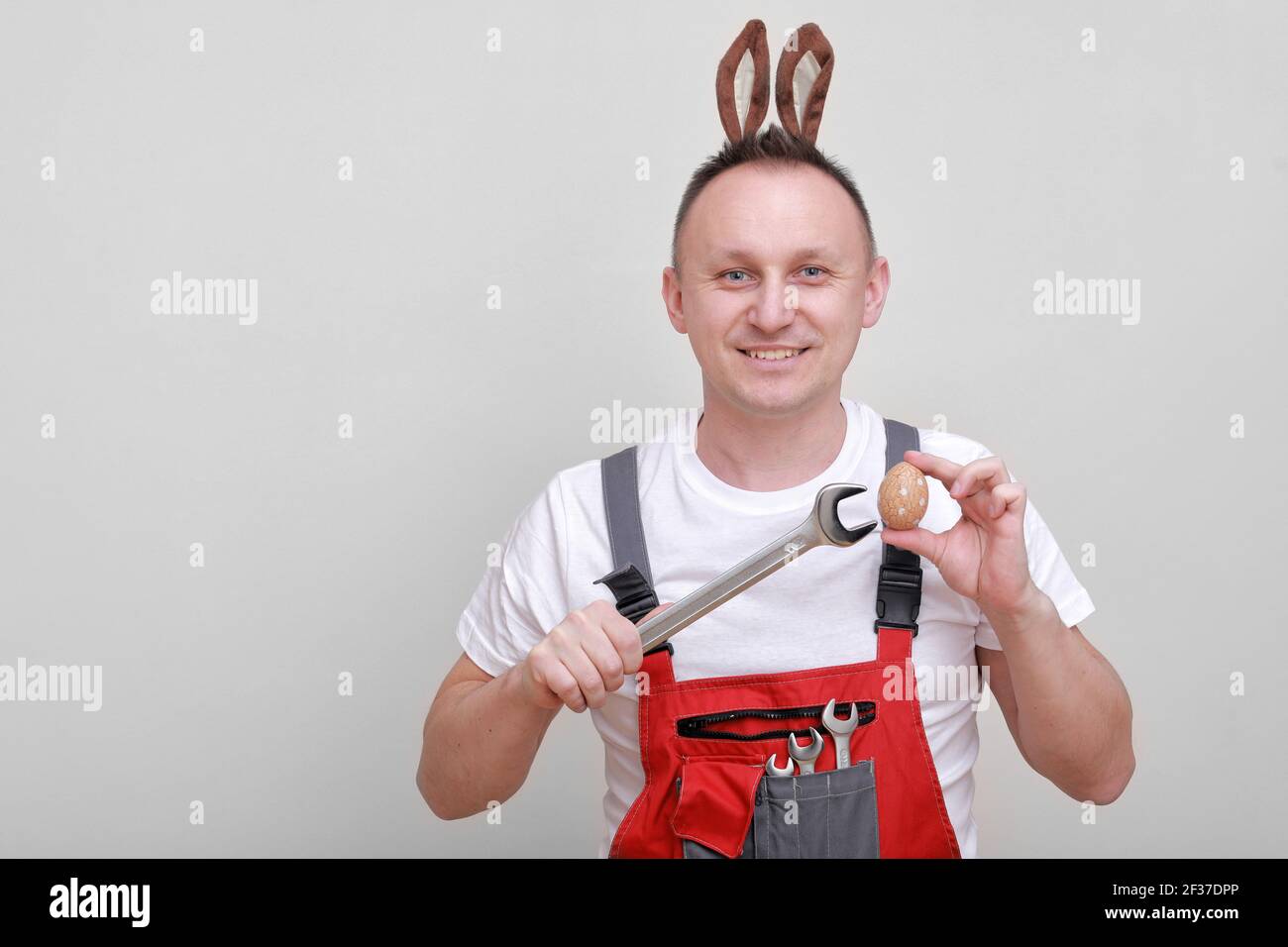 Easter holiday, celebration concept. funny smiling engineer worker or ...