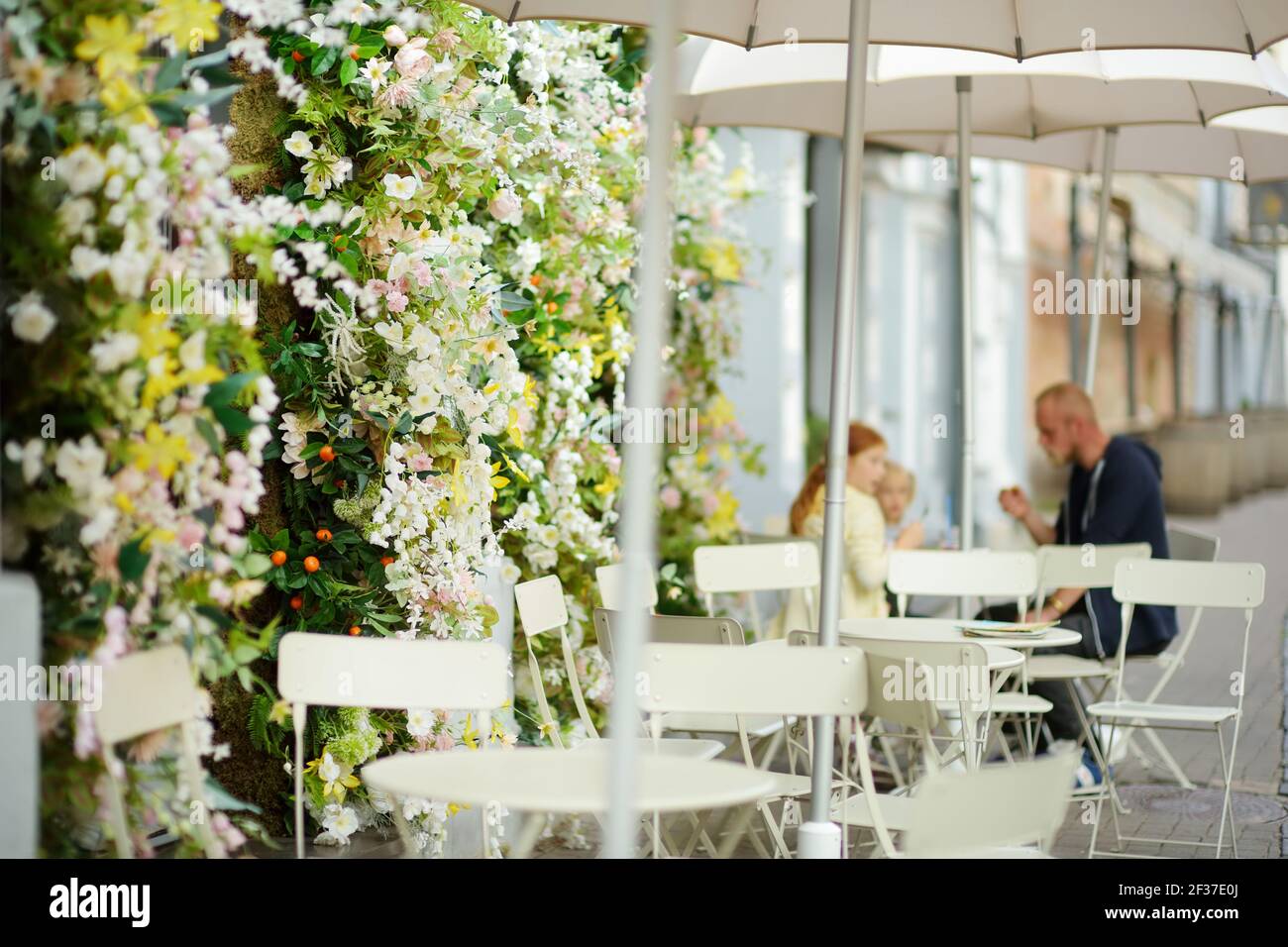 Outdoor restaurant table beautifully decorated with plants and flowers ...