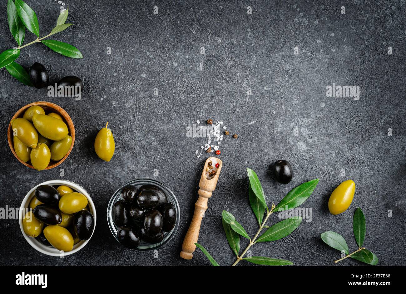 Mix of green and black olives in bowl with leaves. Italian food. Top ...