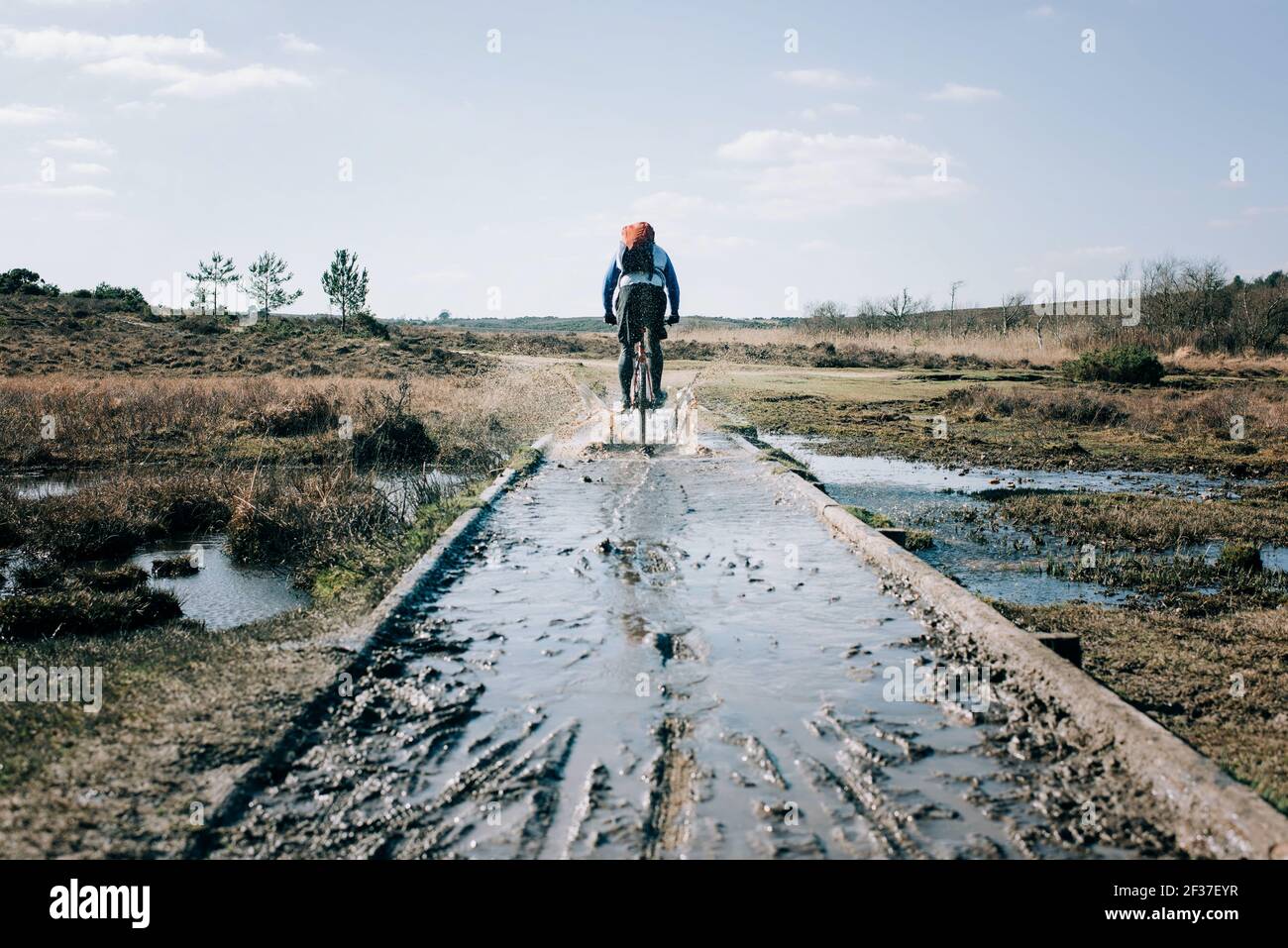 Riding a bike through a puddle hi-res stock photography and images - Alamy