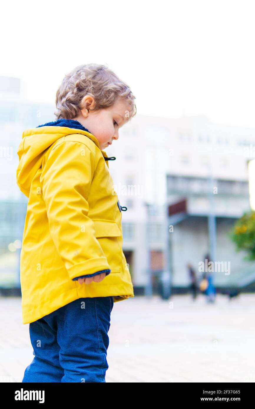 sad two year old boy looking down sad Stock Photo - Alamy