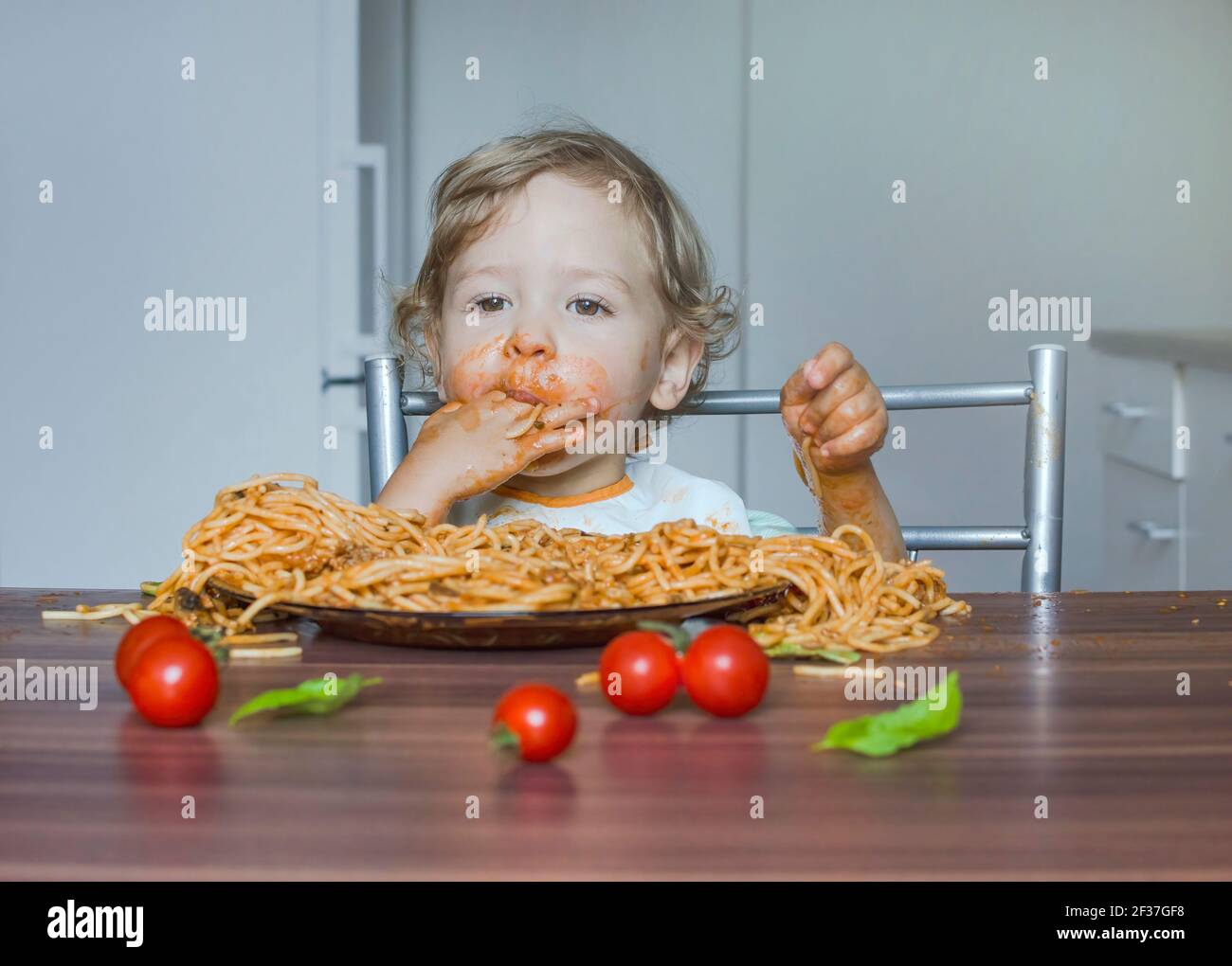 Boy eating messy spaghetti dinner hi-res stock photography and images ...