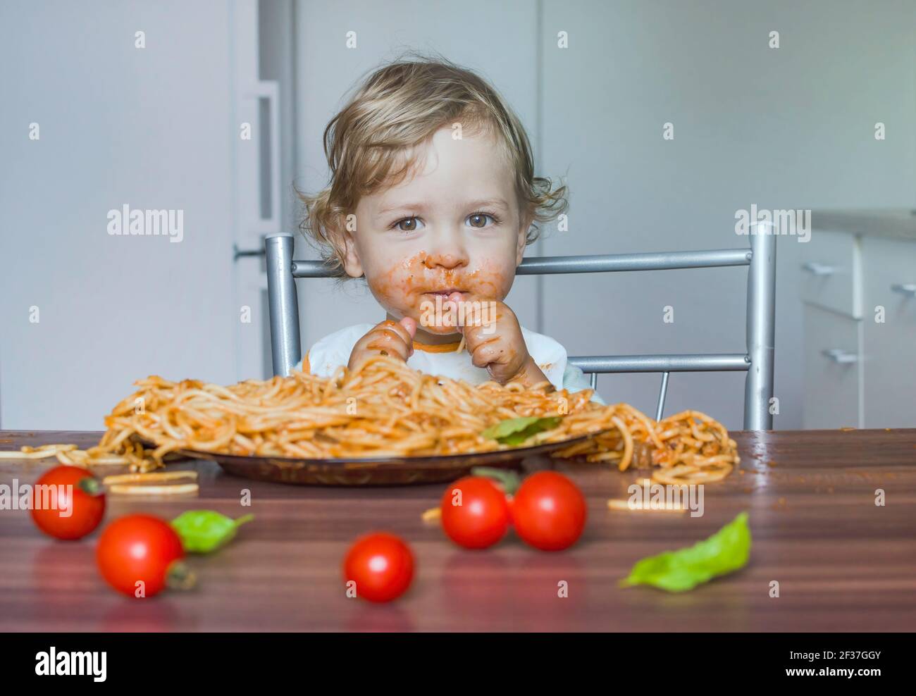 Boy eating messy spaghetti dinner hi-res stock photography and images ...