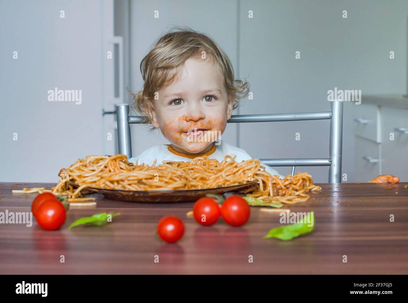 Boy eating messy spaghetti dinner hi-res stock photography and images ...
