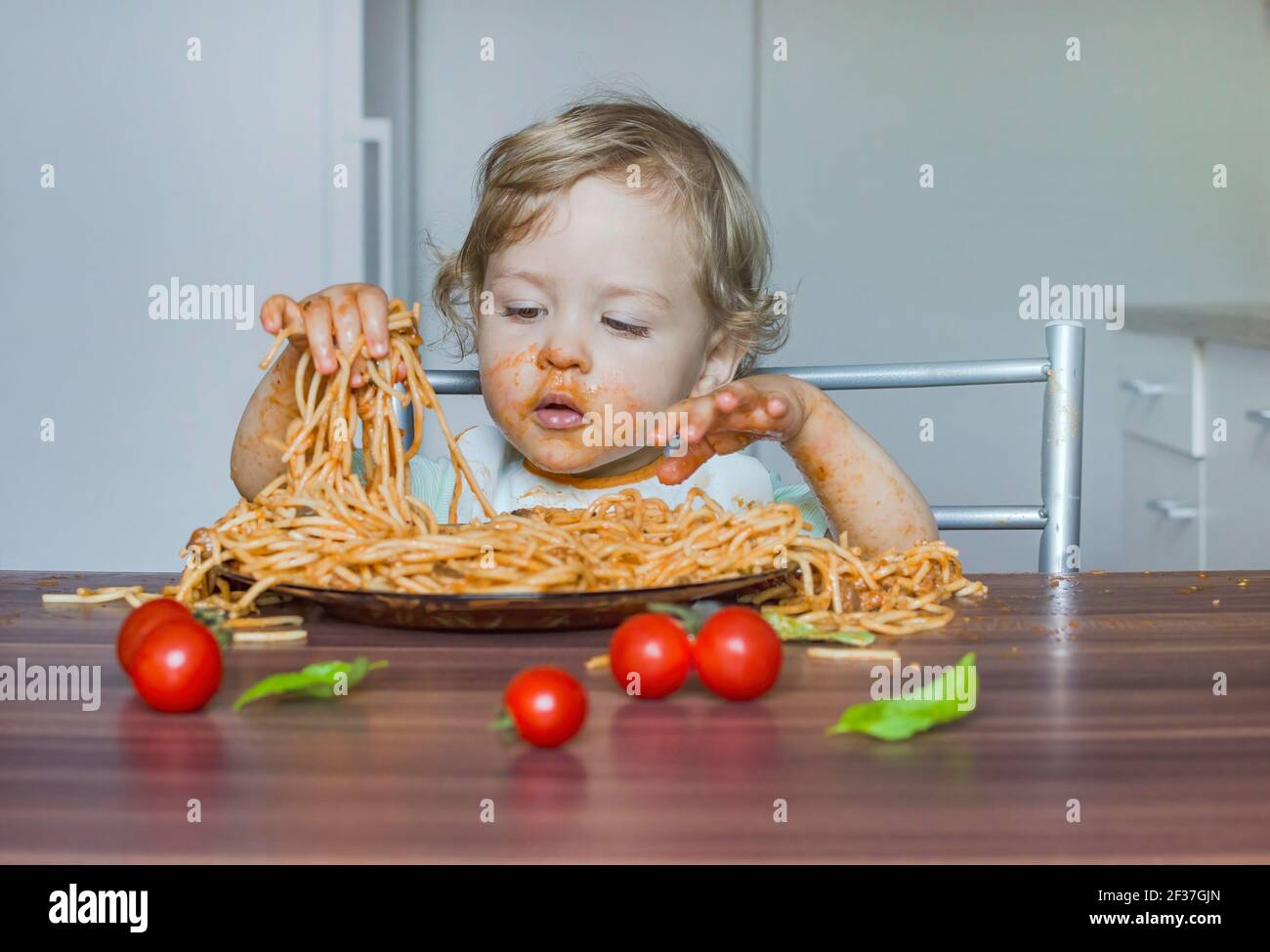 Boy eating messy spaghetti dinner hi-res stock photography and images ...