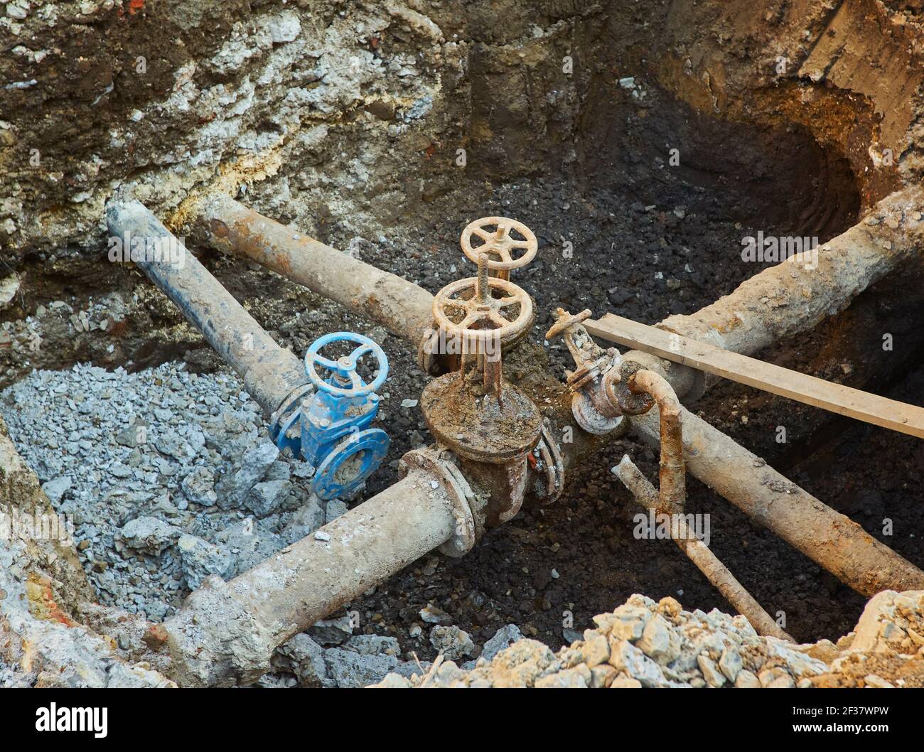 Old city water main taps, a hole dug to repair or replace water supply ...