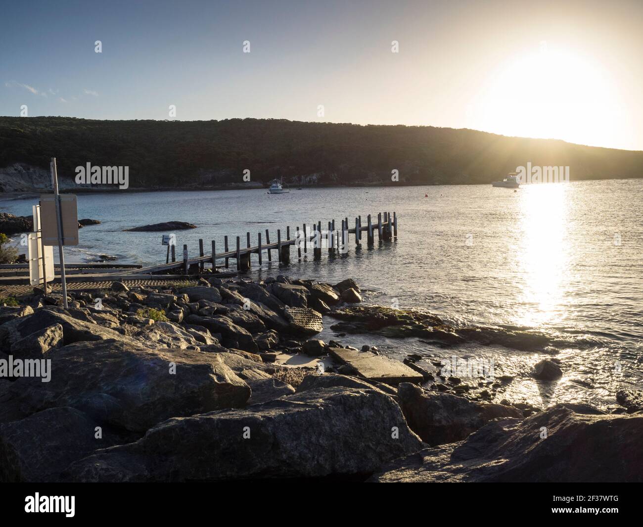 Fishery Beach boat harbour with boat ramp and fishing jetty at sunset ...