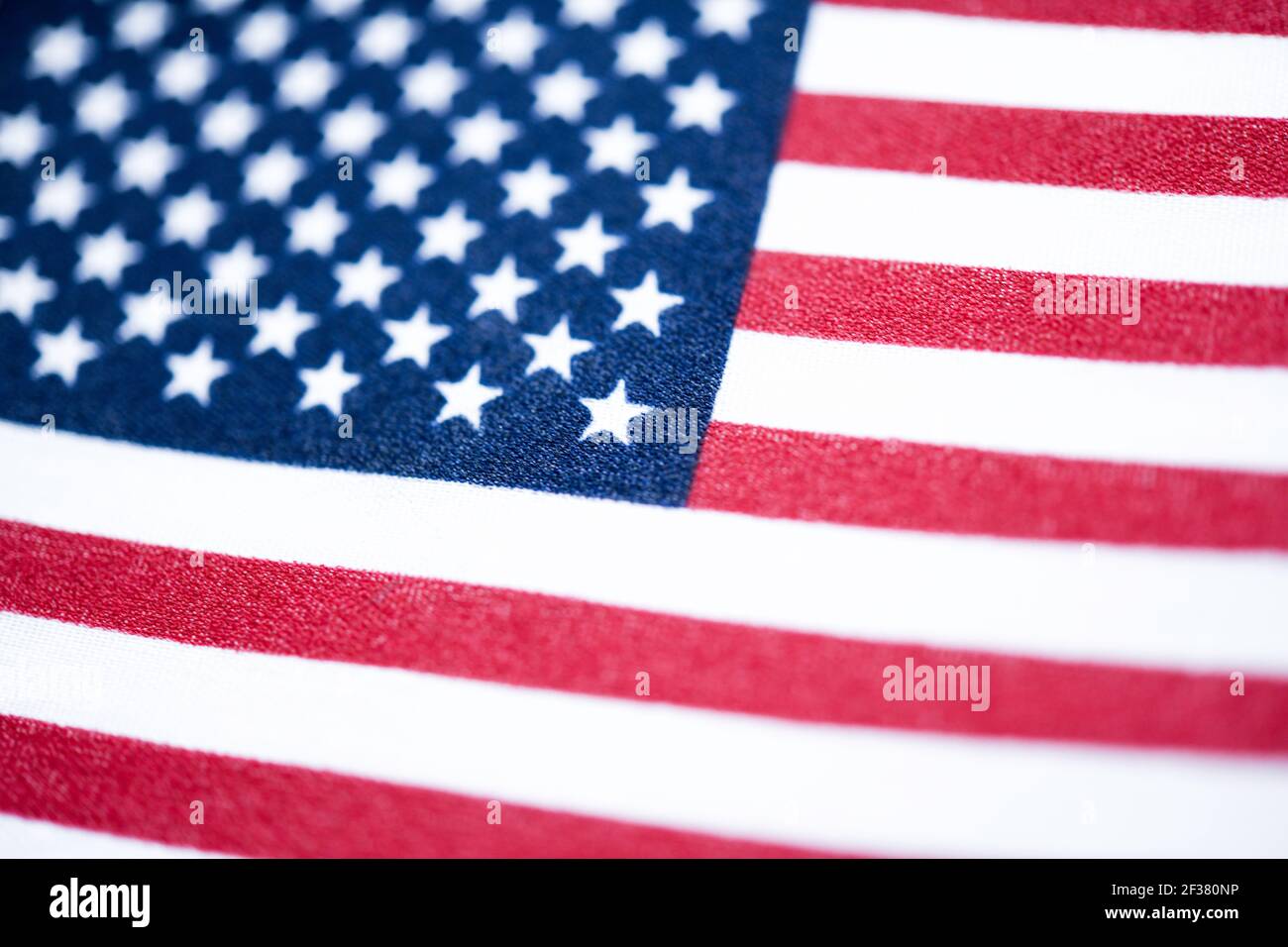 A macro shot with selective focus of a small handheld American flag on ...