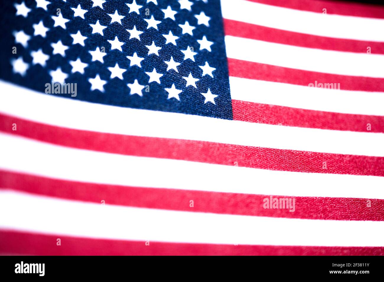 A macro shot with selective focus of a small handheld American flag on ...