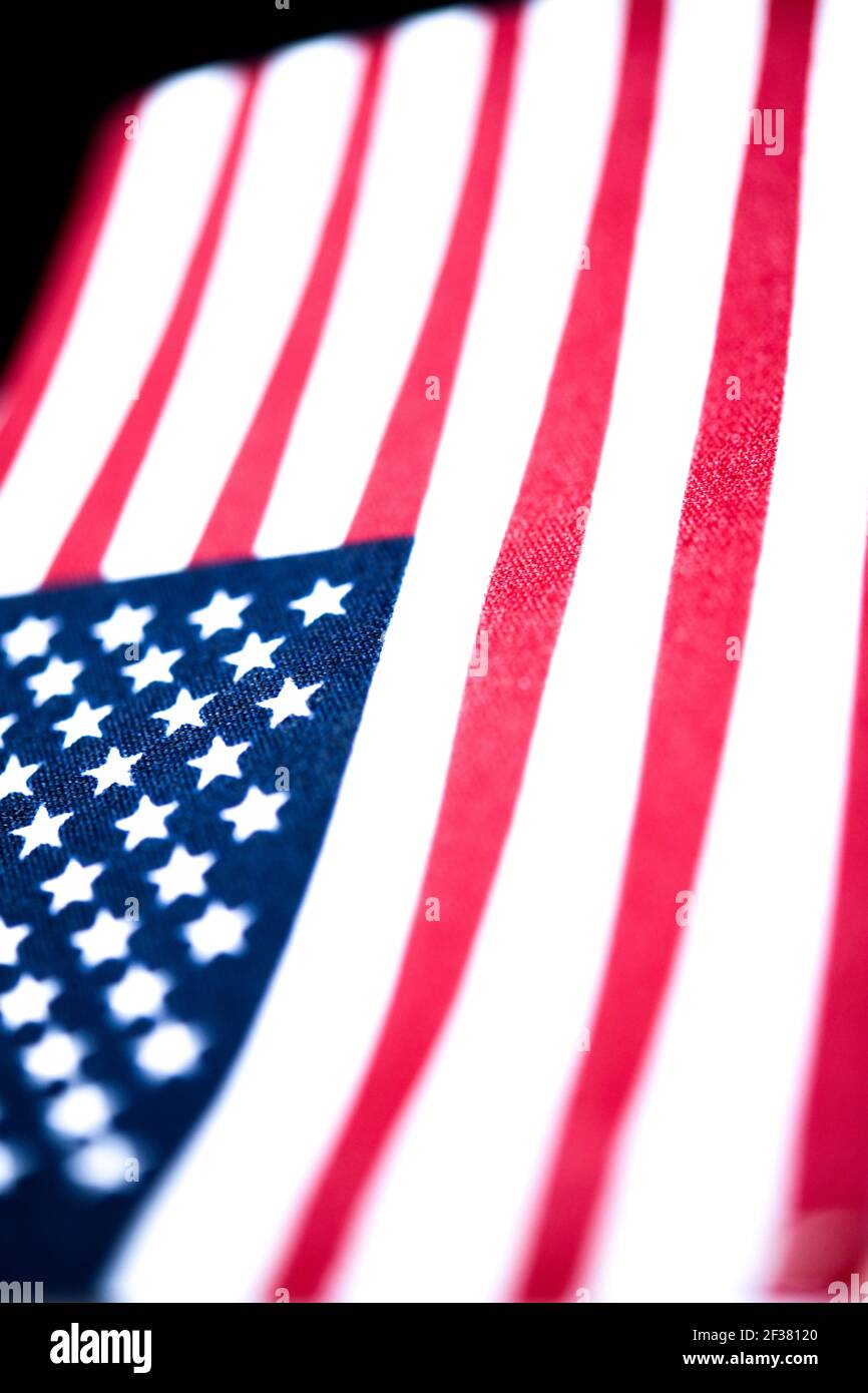 A macro shot with selective focus of a small handheld American flag on ...