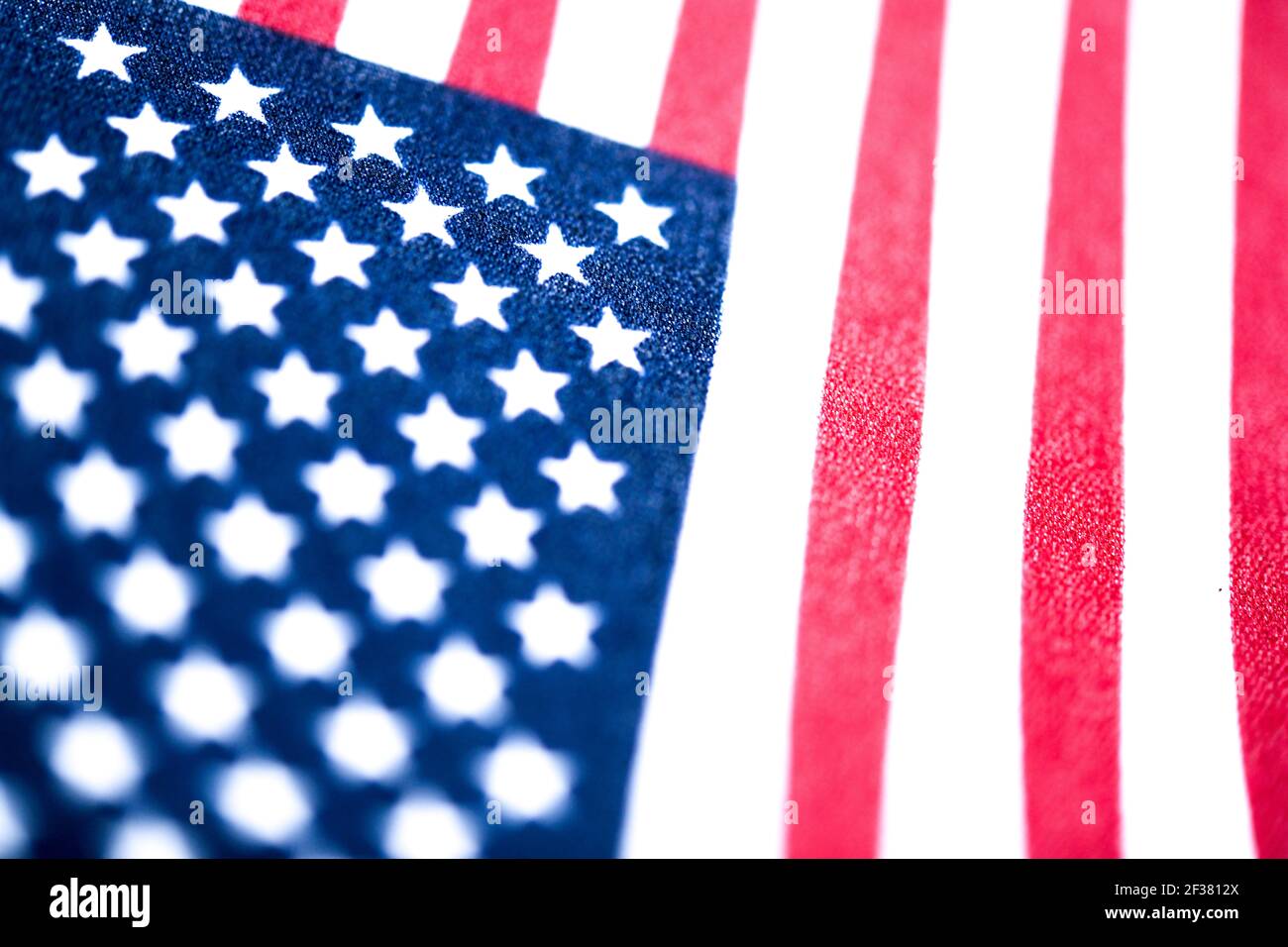 A macro shot with selective focus of a small handheld American flag on ...