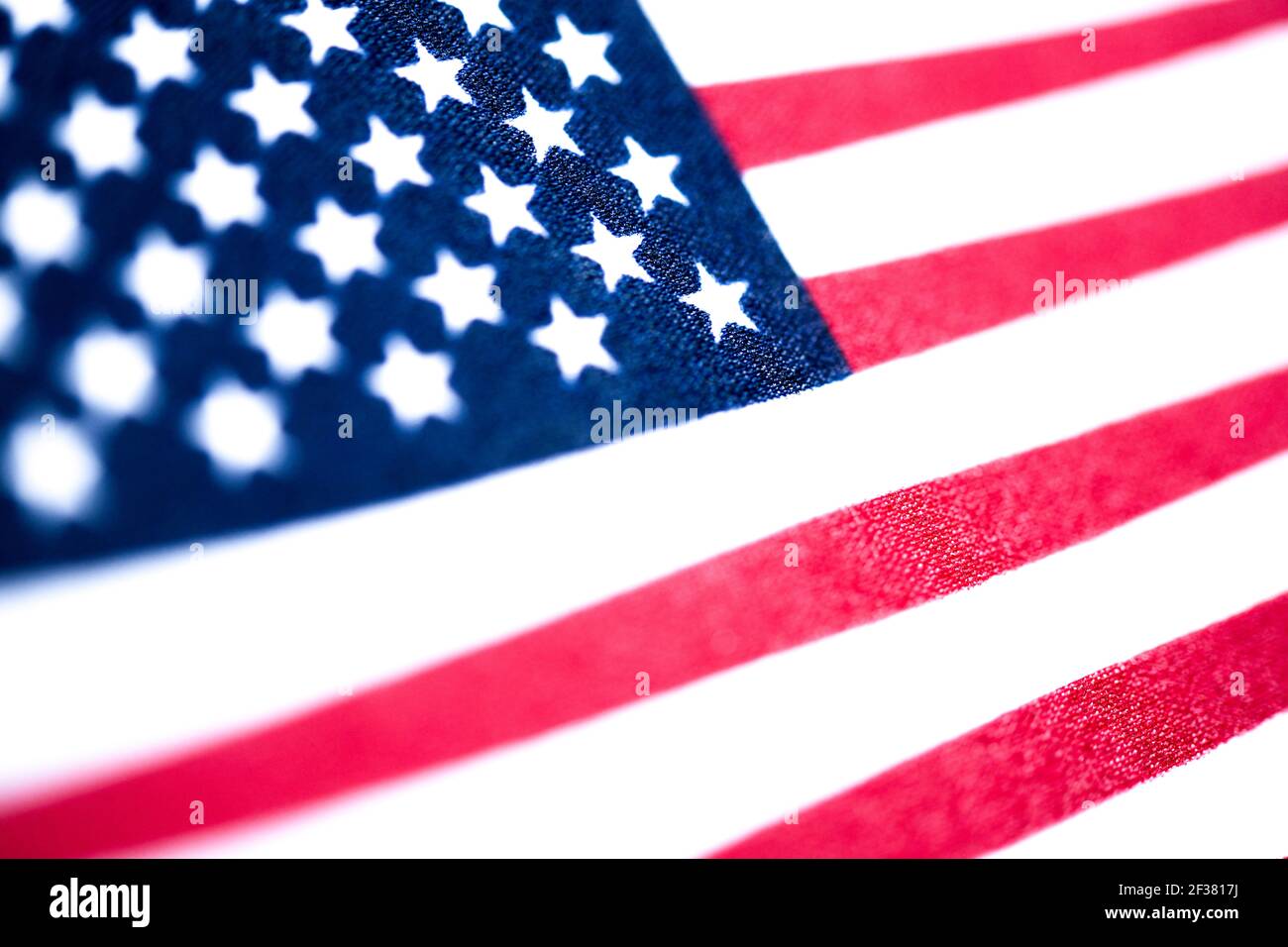 A macro shot with selective focus of a small handheld American flag on ...