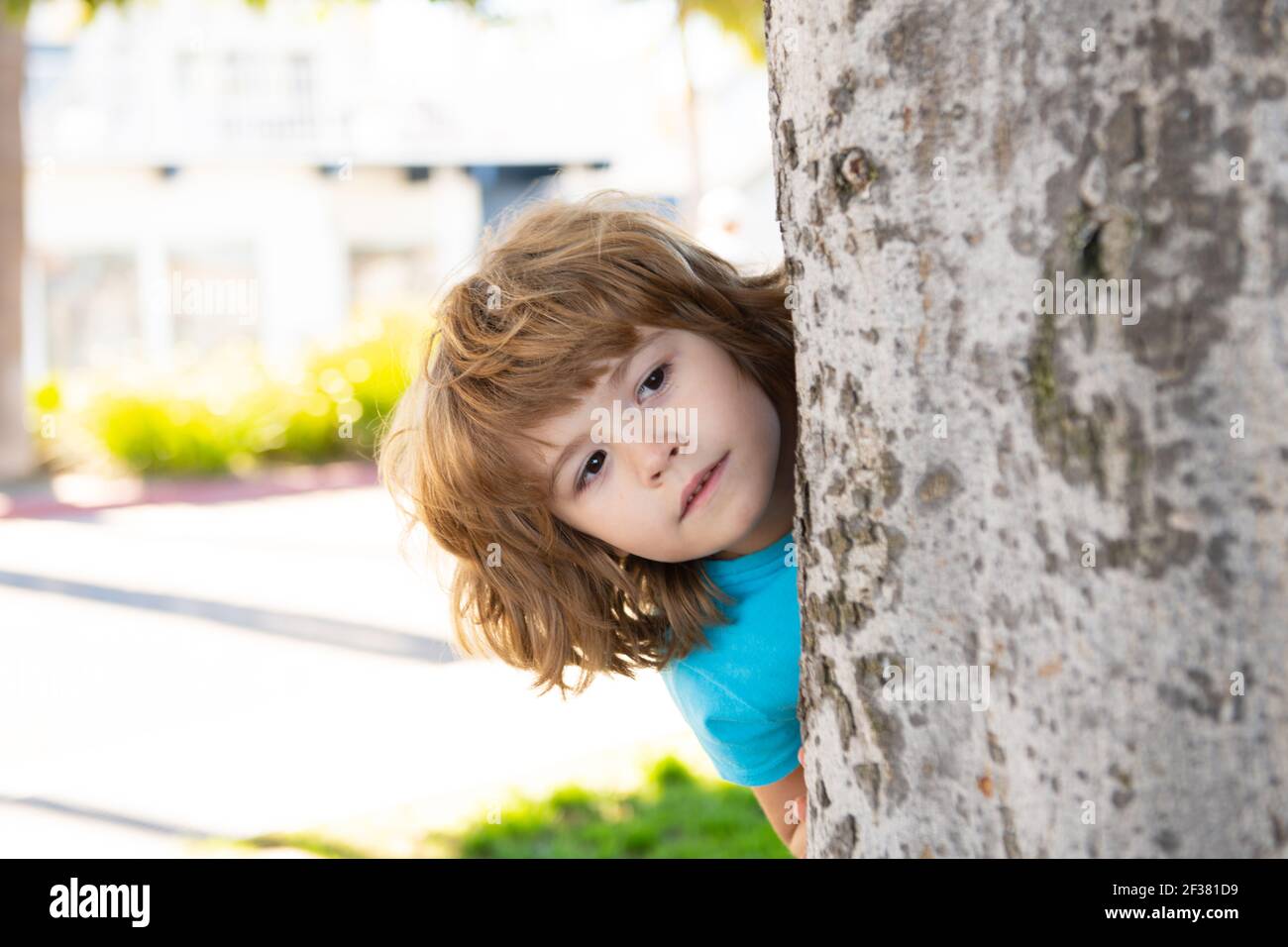 Hide and seek. Peekaboo. Little kid hide by tree. Kids vacation Stock ...