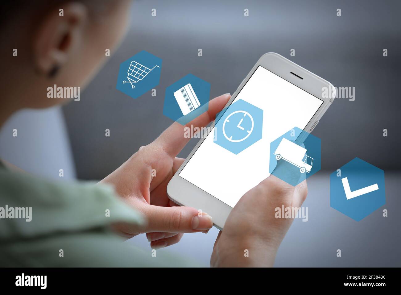 Woman with mobile phone using delivery service application Stock Photo ...