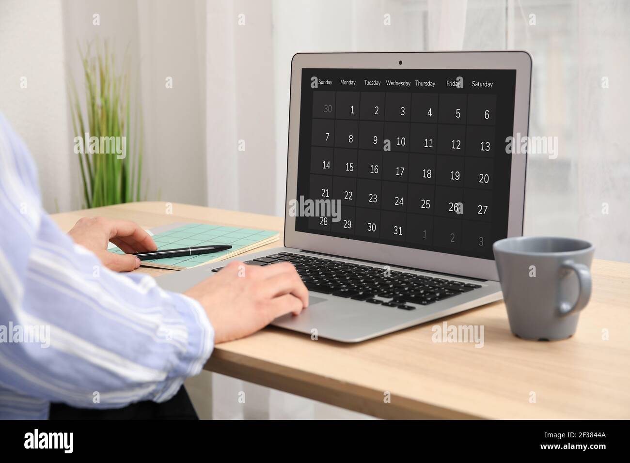 Woman using calendar notebook hi-res stock photography and images - Alamy
