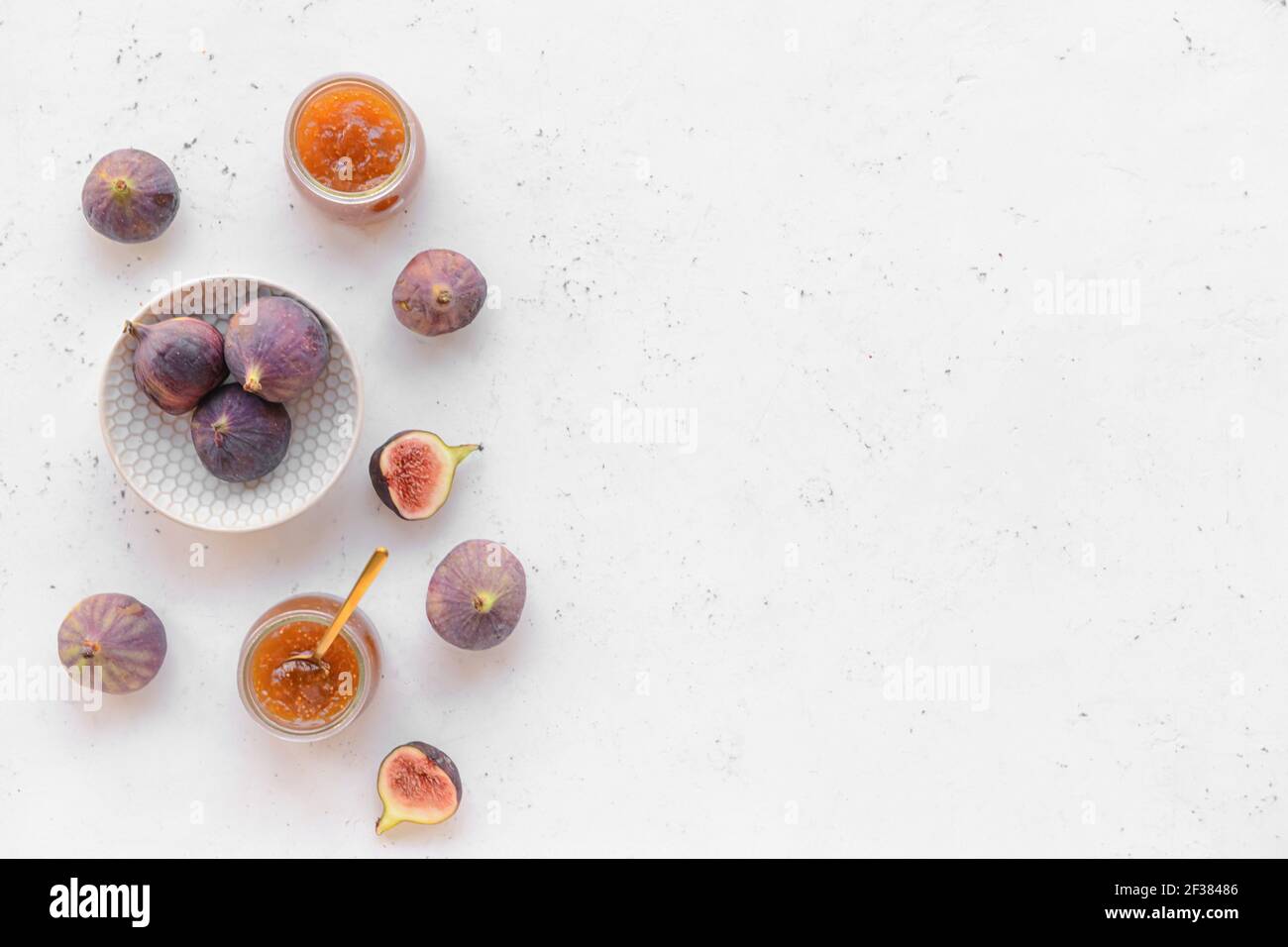 Composition with sweet fig jam on light background Stock Photo - Alamy
