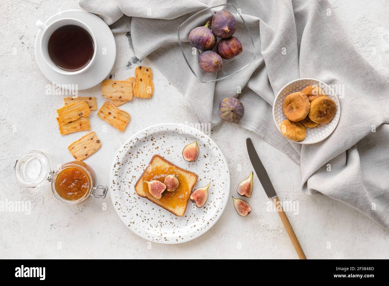 Composition with sweet fig jam on grunge background Stock Photo - Alamy