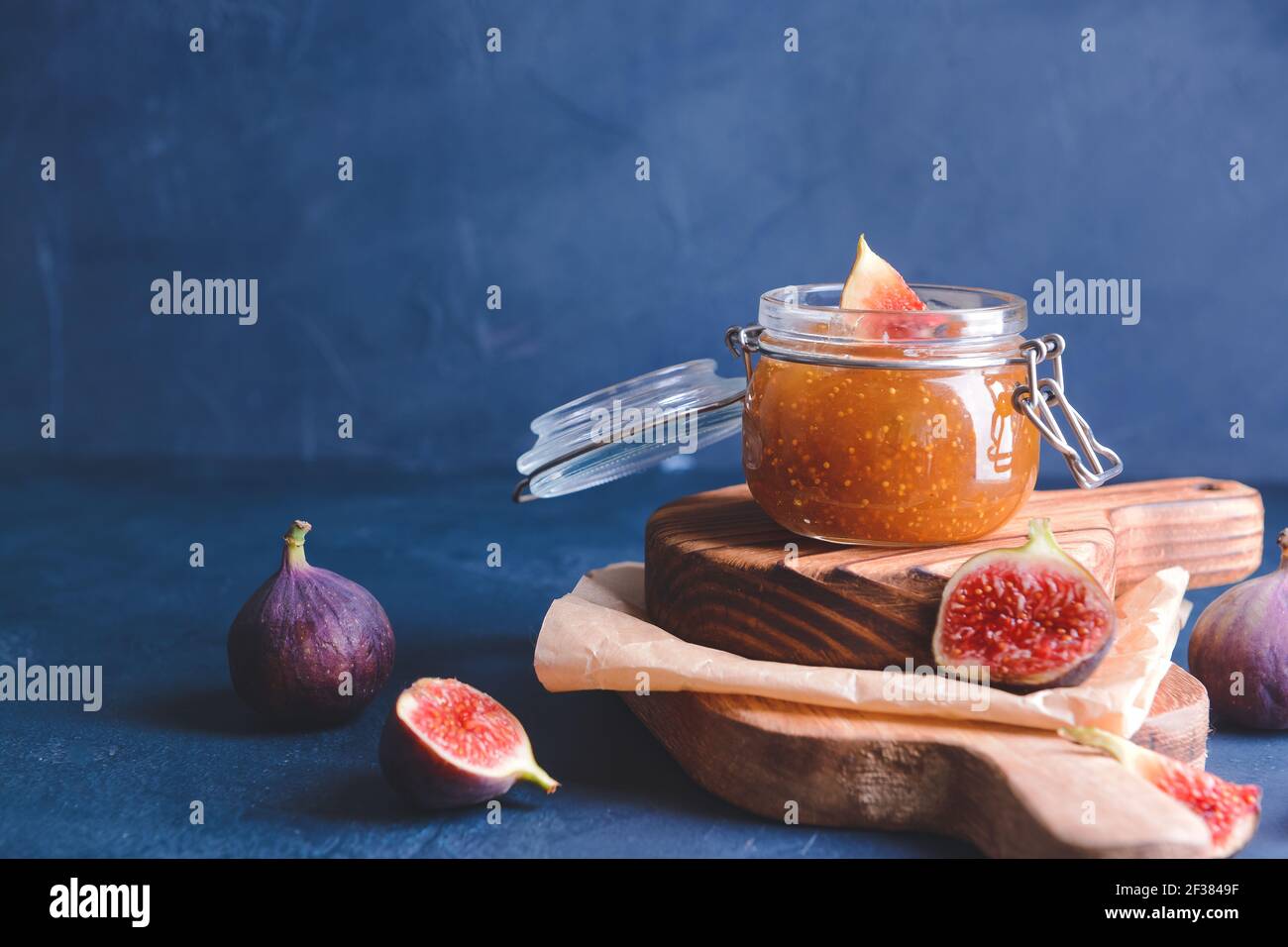Composition with sweet fig jam on color background Stock Photo - Alamy