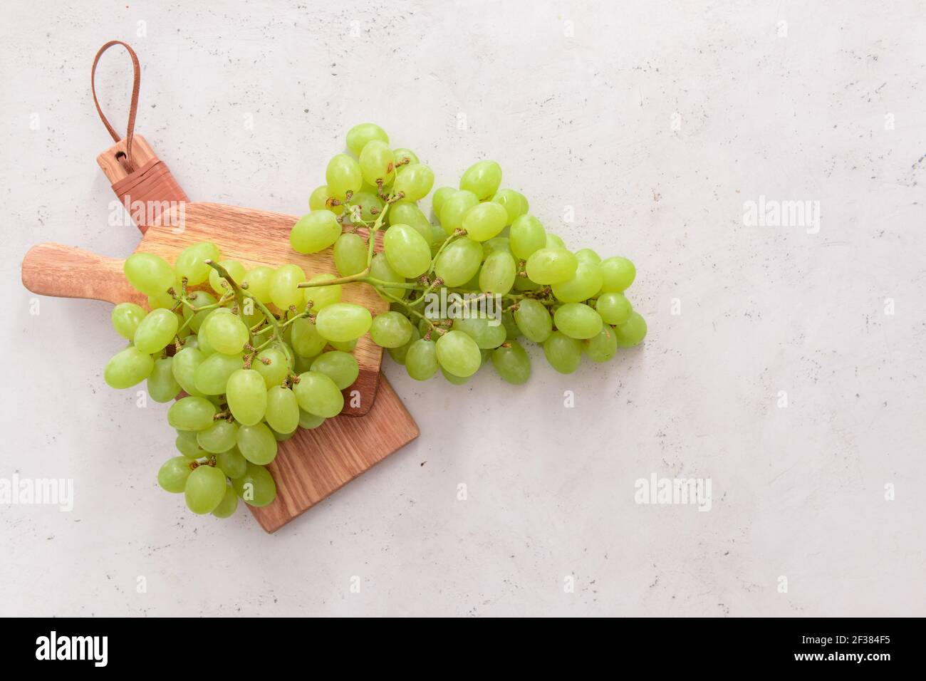 Boards with ripe green grapes on white background Stock Photo - Alamy