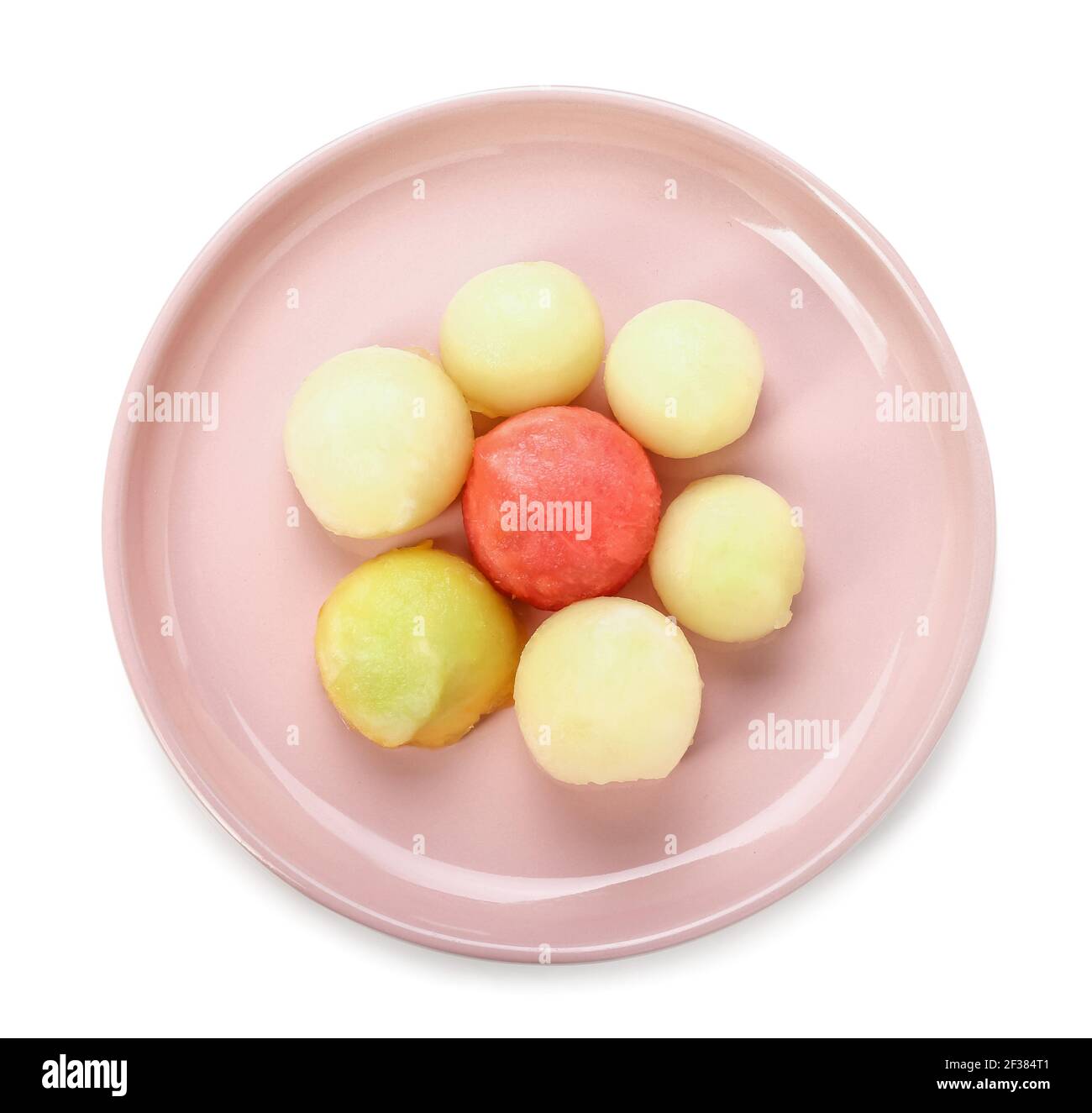Plate with sweet fruit balls on white background Stock Photo - Alamy