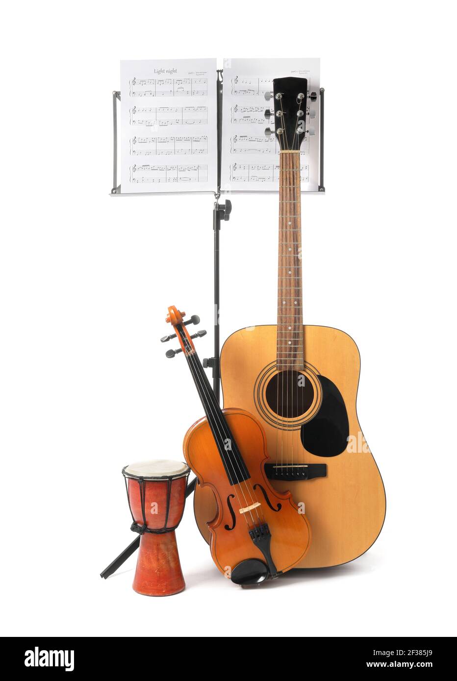 Note stand with music sheets and different musical instruments on white ...