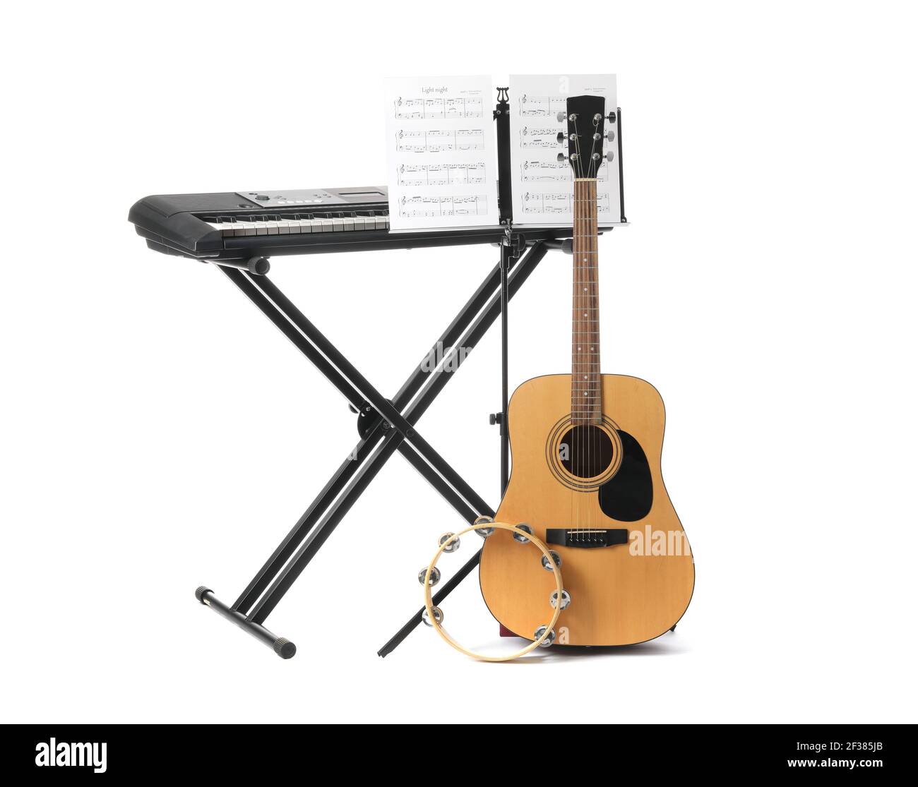 Note stand with music sheets and different musical instruments on white ...