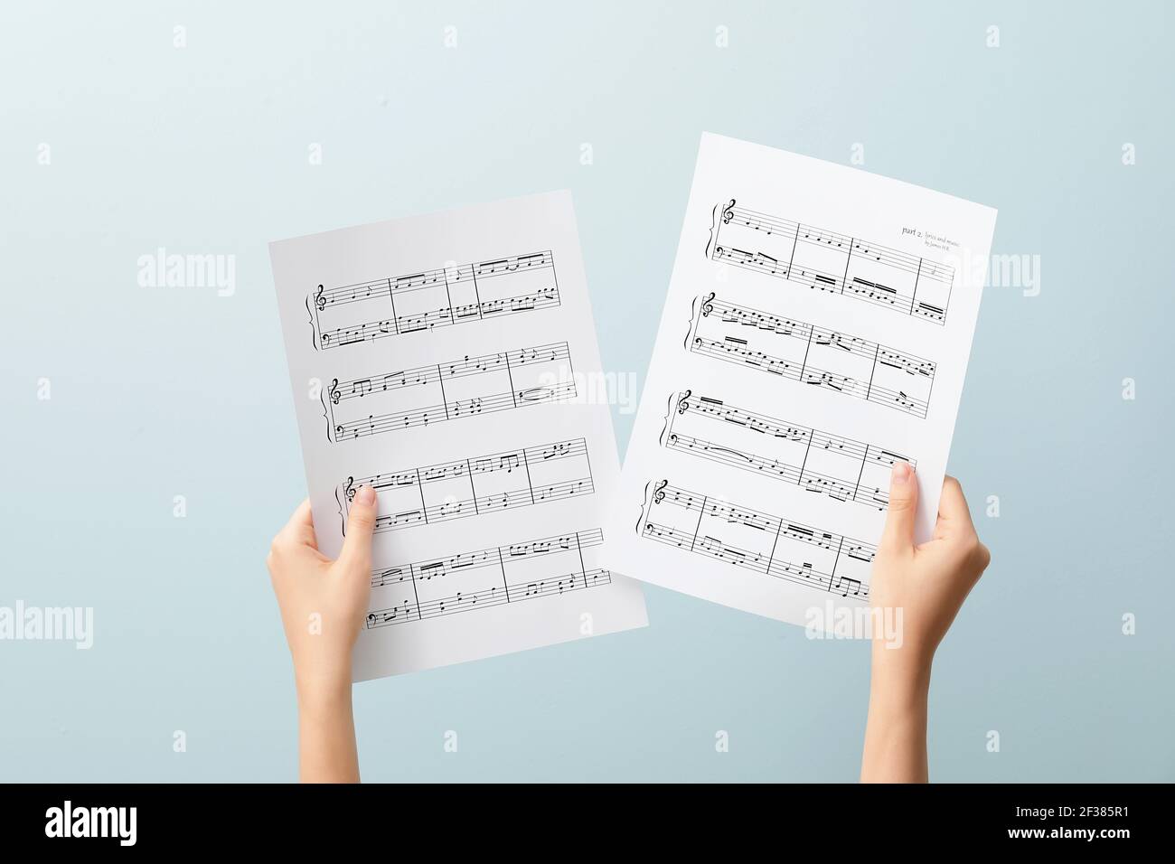 Woman holding music notes on color background Stock Photo - Alamy