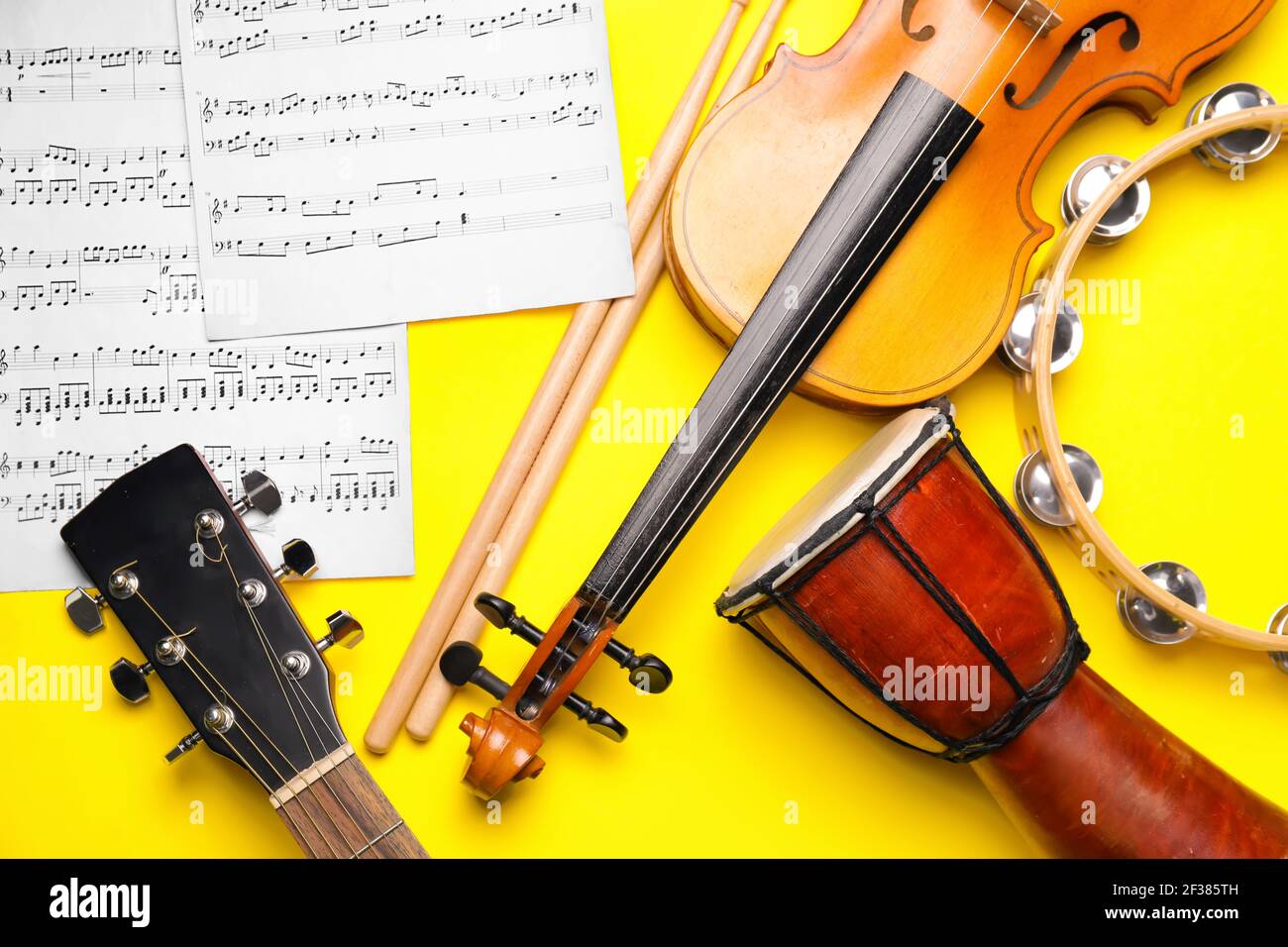 Different musical instruments and music notes on color background ...