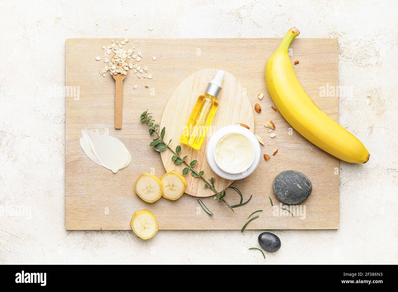 Composition with banana cosmetics on light background Stock Photo - Alamy