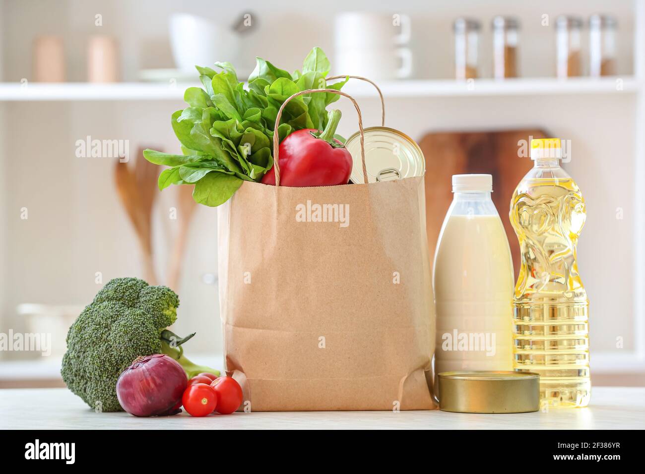 Paper bag with different products on table in kitchen Stock Photo - Alamy
