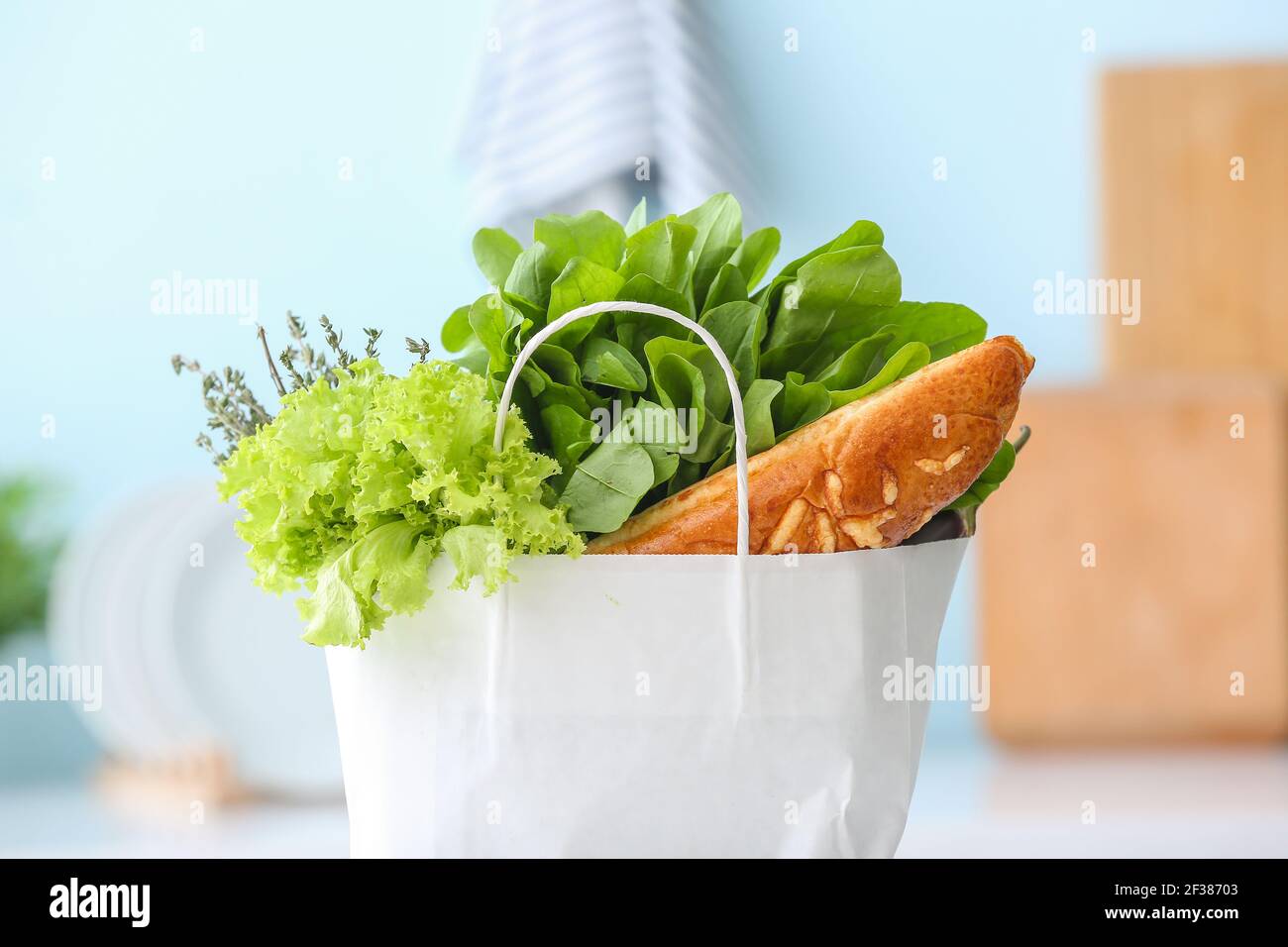 Paper bag with different products on table in kitchen Stock Photo - Alamy