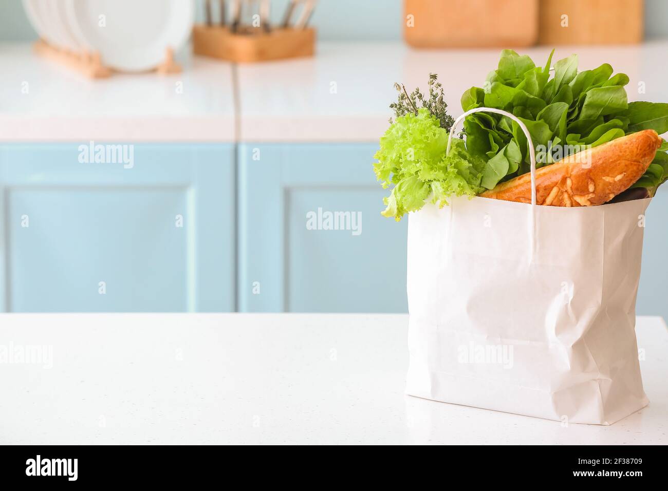 Paper bag with different products on table in kitchen Stock Photo - Alamy