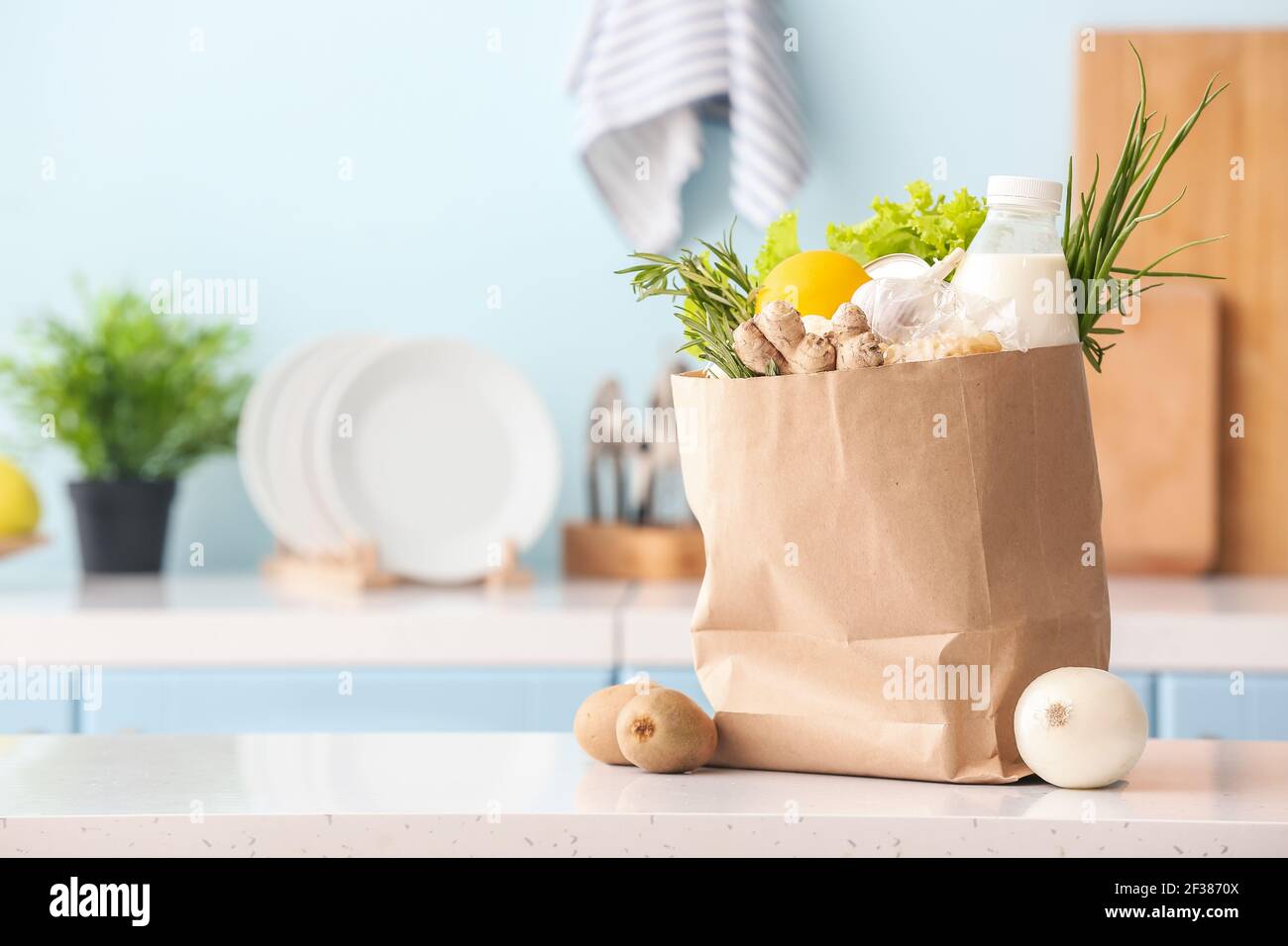 Paper bag with different products on table in kitchen Stock Photo - Alamy