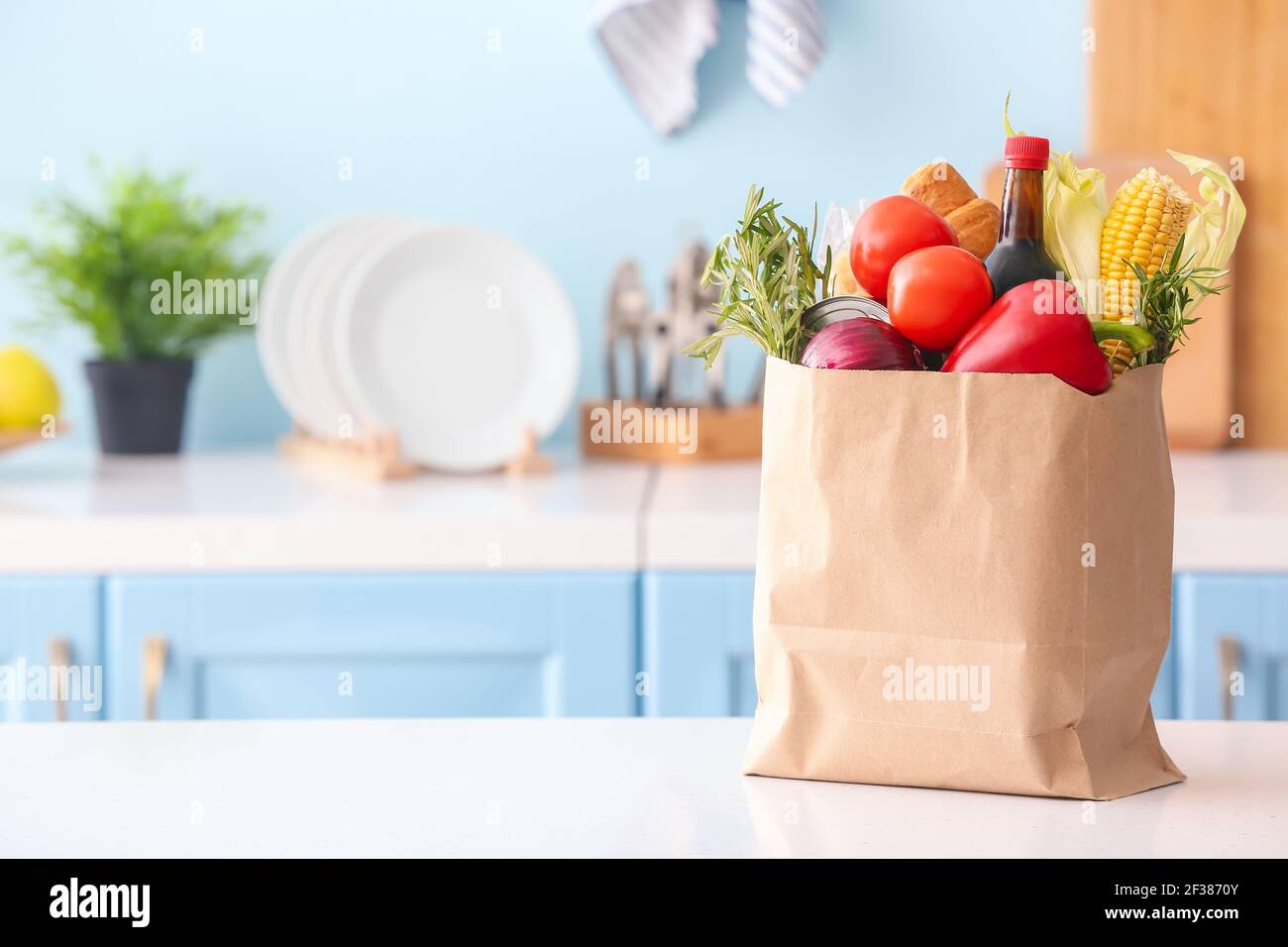 Paper bag with different products on table in kitchen Stock Photo - Alamy