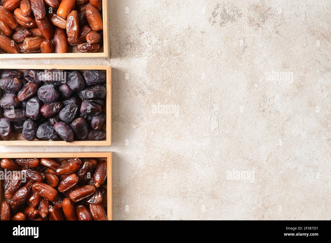 Wooden boxes with sweet dried dates on light background Stock Photo - Alamy