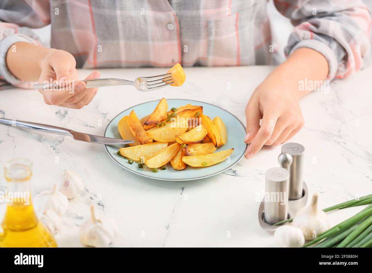 Person eating plate baked potato hi-res stock photography and images ...