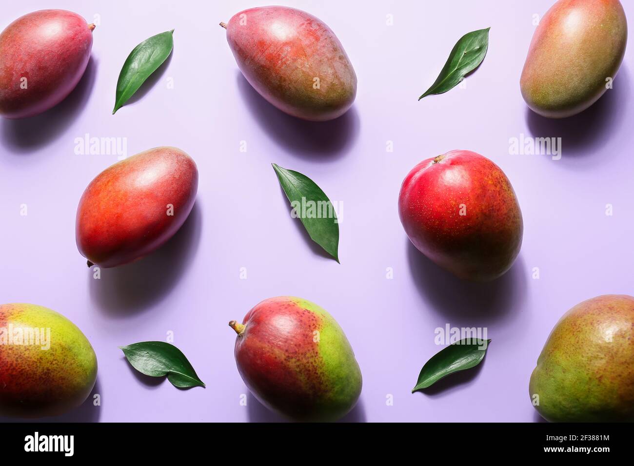 Sweet ripe mangoes on color background Stock Photo - Alamy