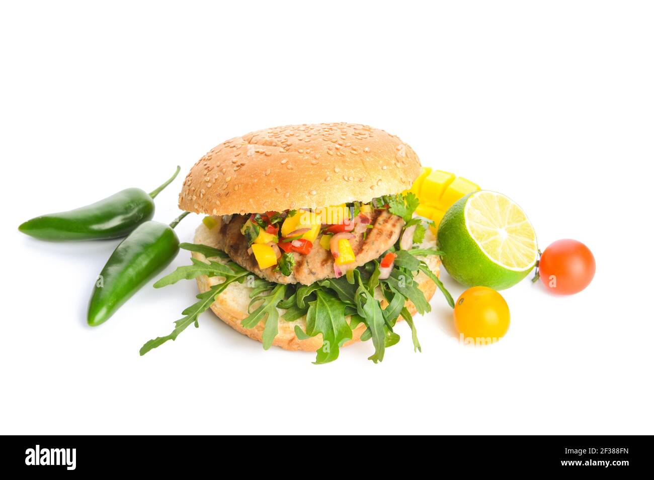 Burger with tasty mango salsa on white background Stock Photo - Alamy