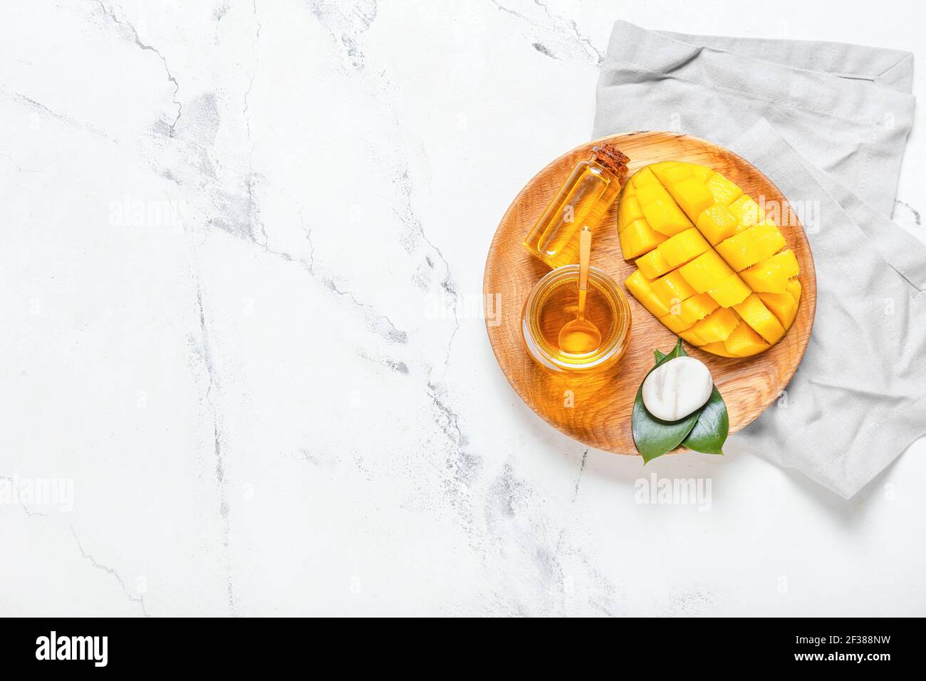 Composition with mango essential oil on light background Stock Photo ...